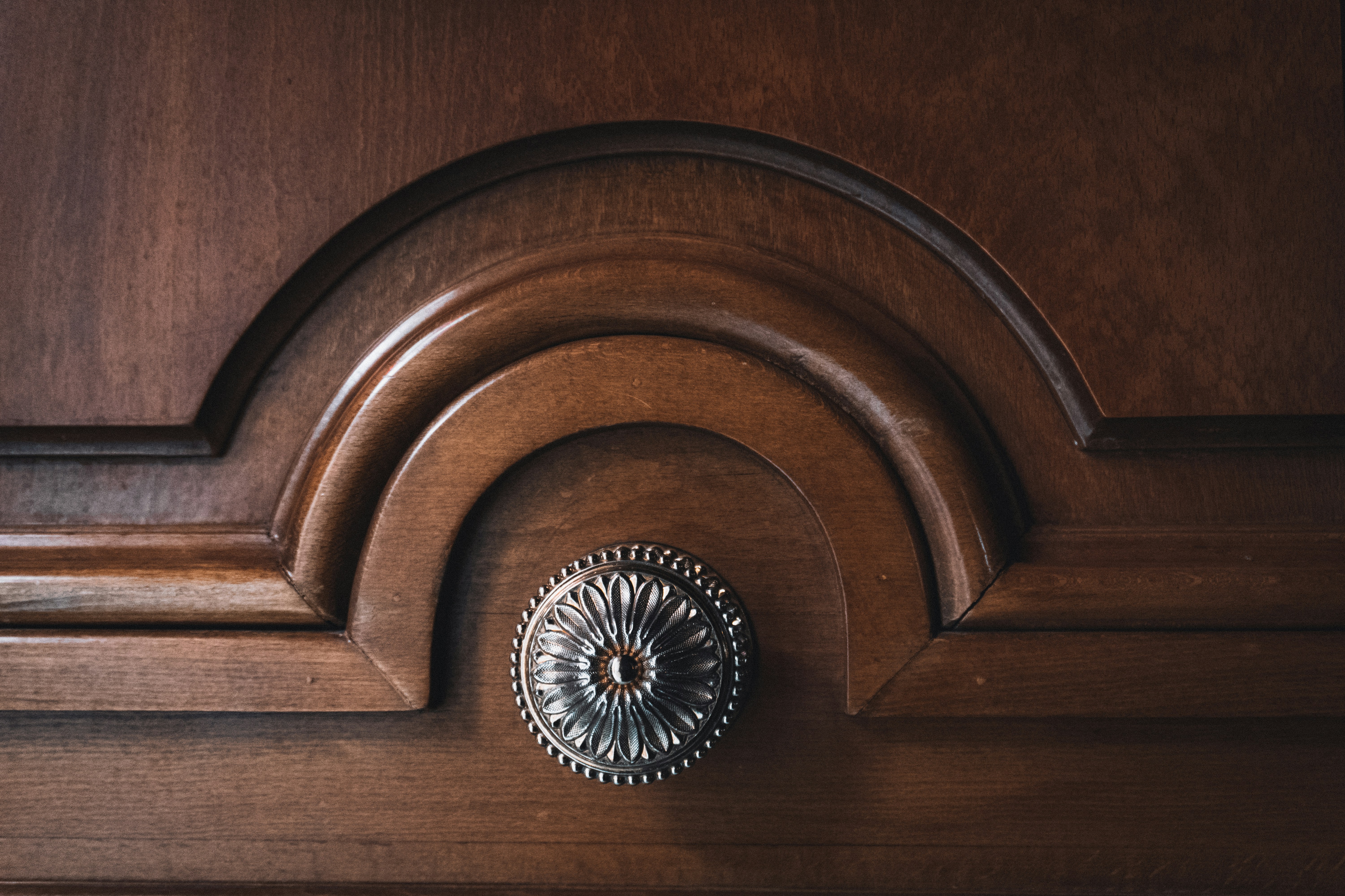 Ornate Cabinet Knob Centered in a Wooden HUD Arch