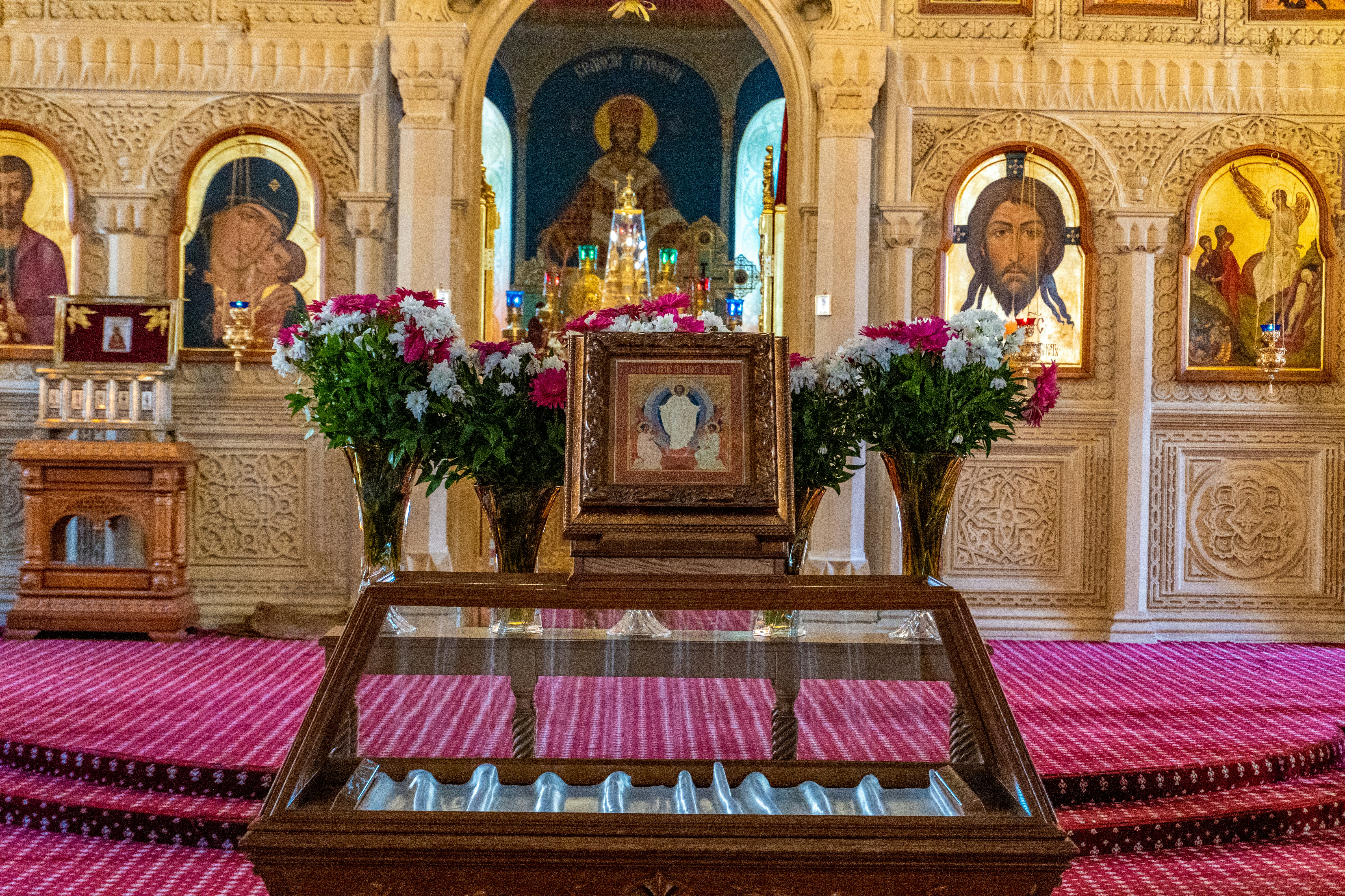 Centered Icon and Flowers Over Time-Ritual Altar in Ornate Orthodox Church