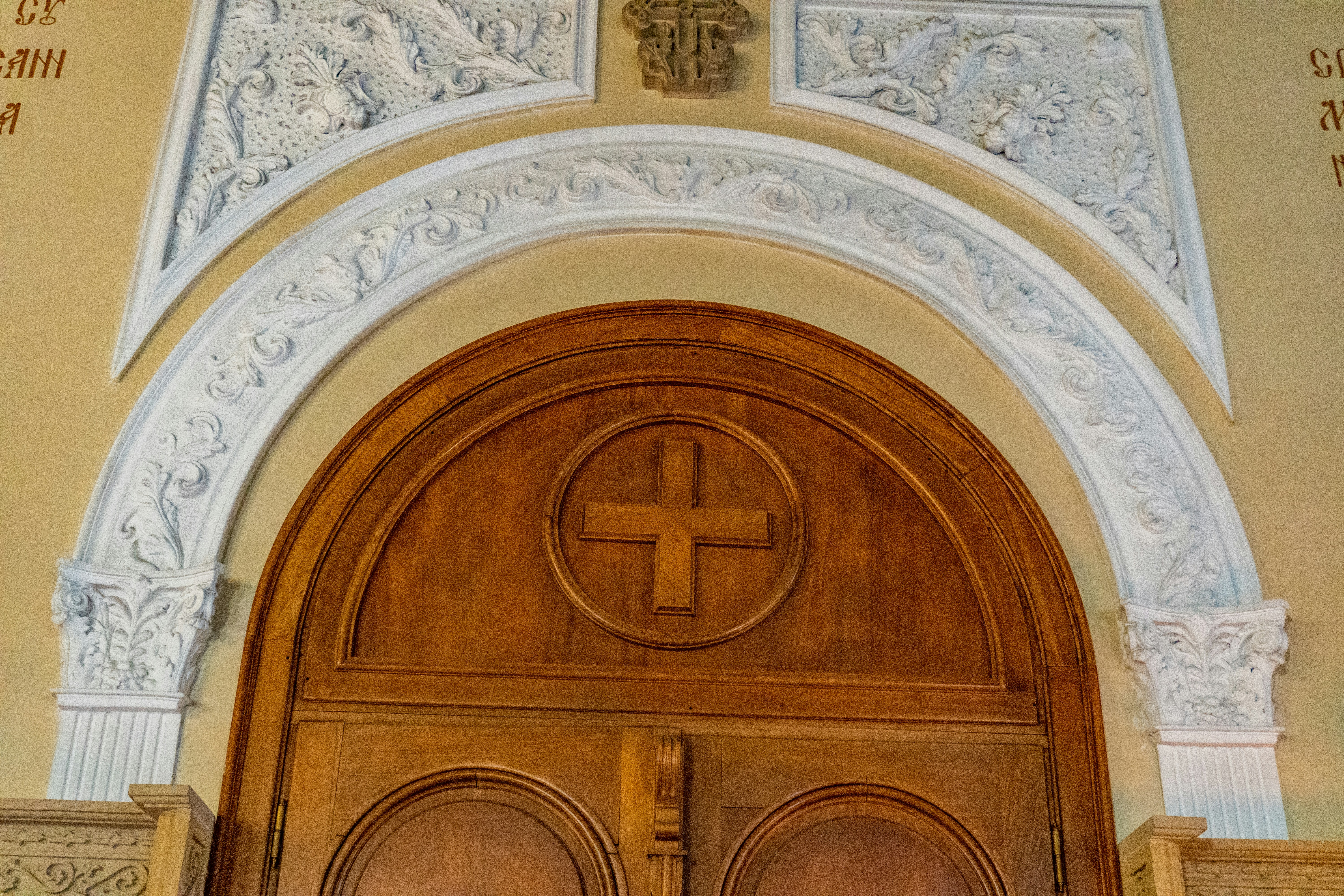 Sacred Archway: Carved White Details Framing a Wooden Portal