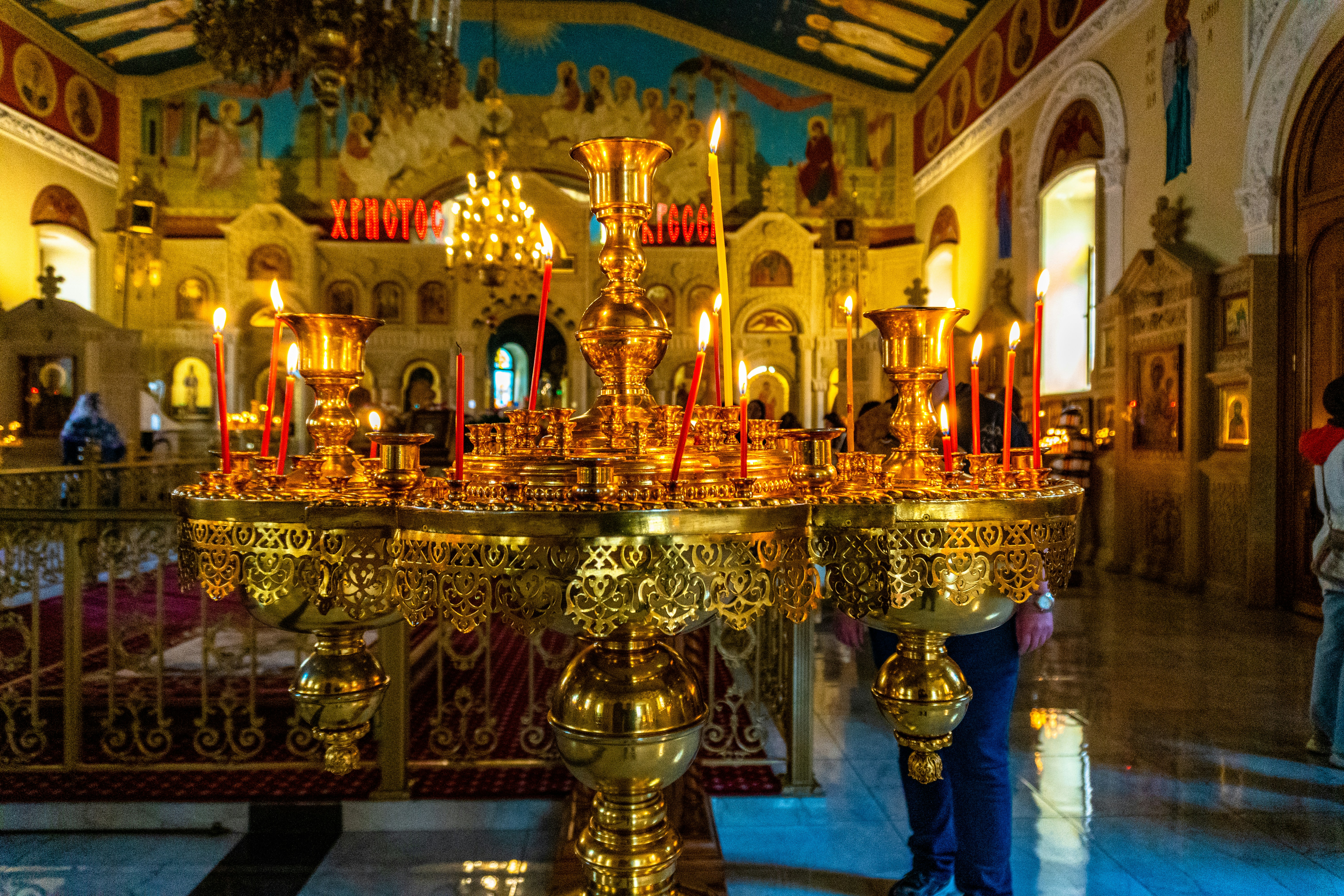 Golden Candles and Iconic Altar in a Sacred Hall