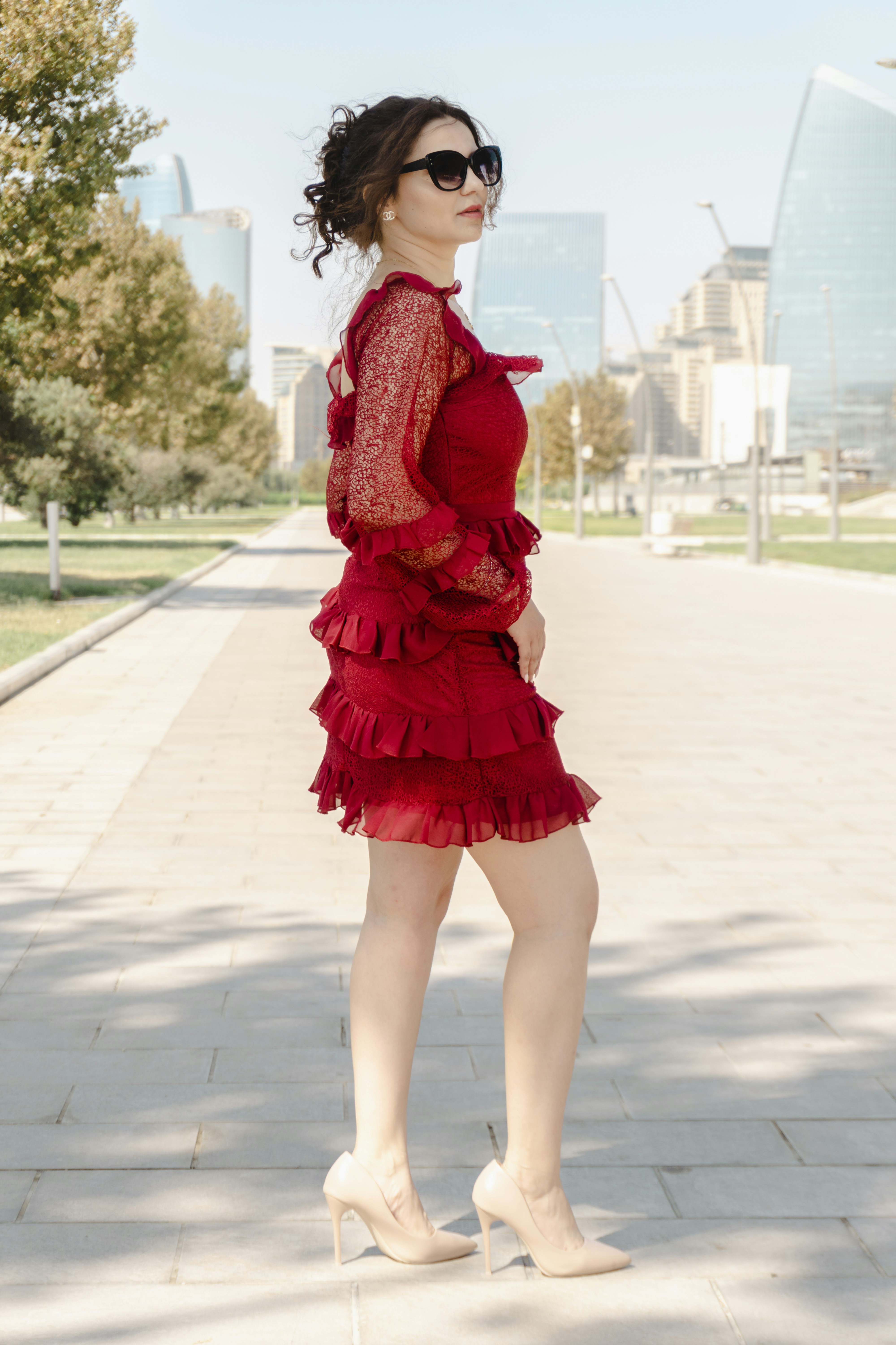 Crimson vogue: a sunlit stride in a city park