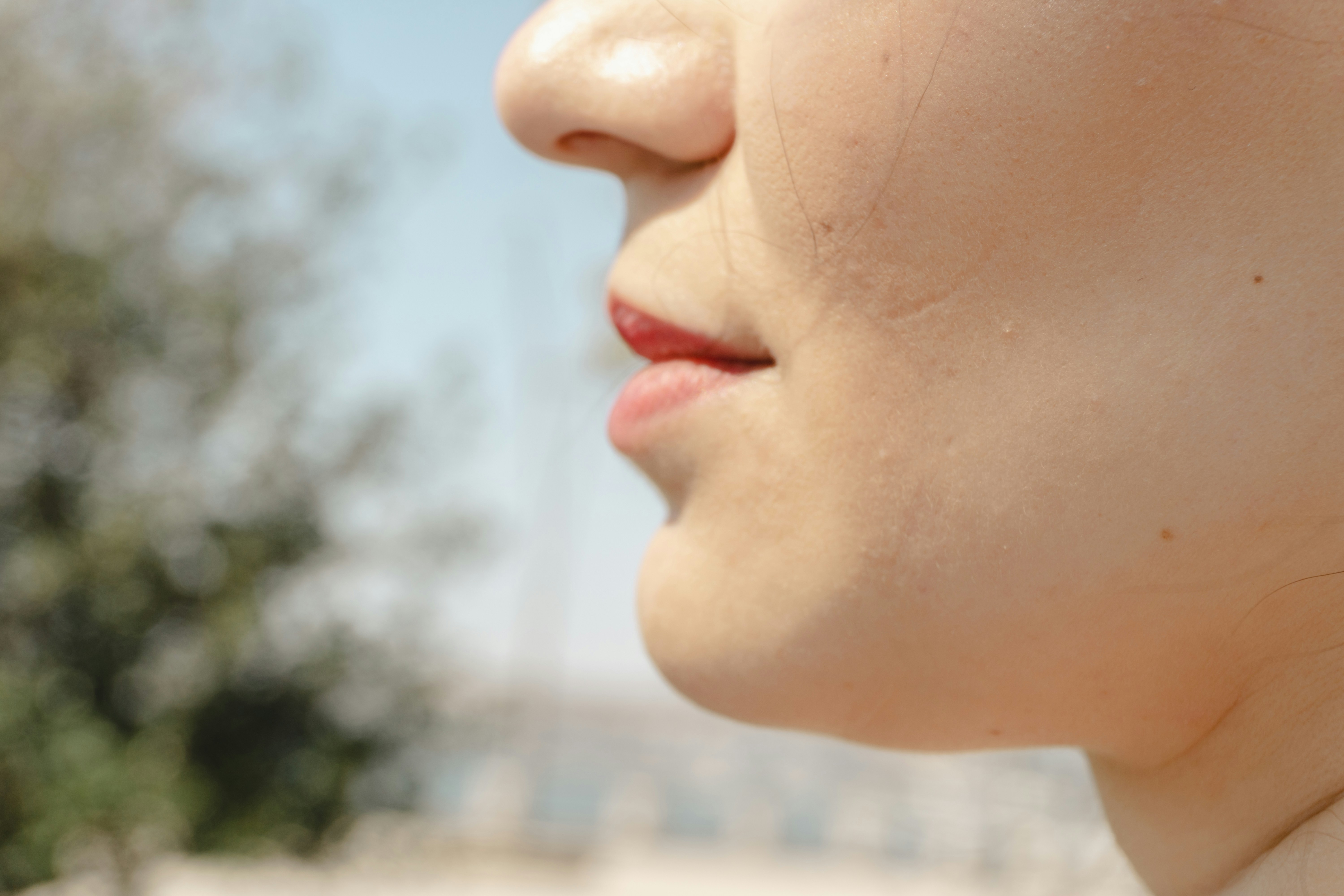 Close-Up of a Quiet Smile: A Side Profile by the Sea Breeze