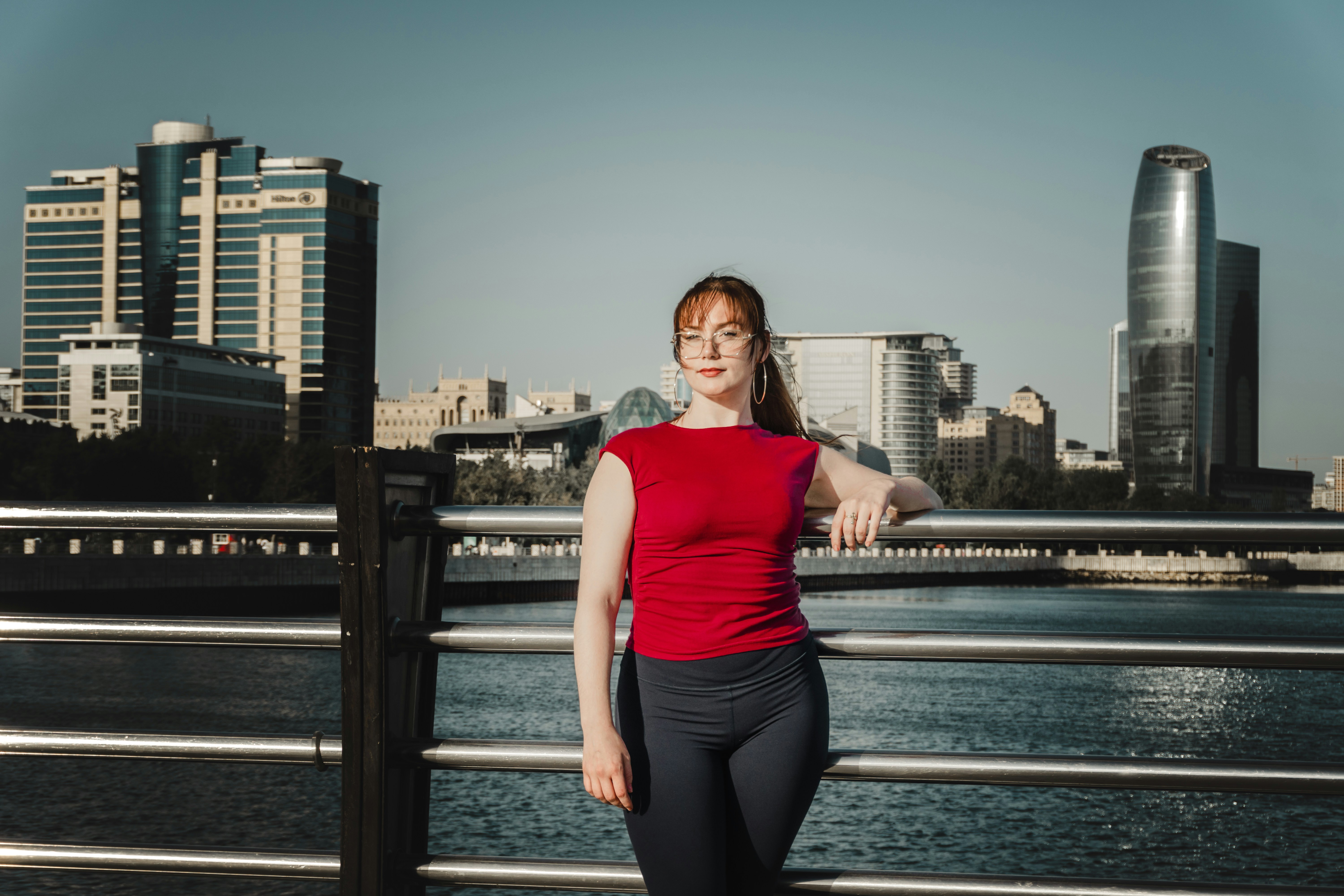 Red-clad Confidence by the Riverside Skyline