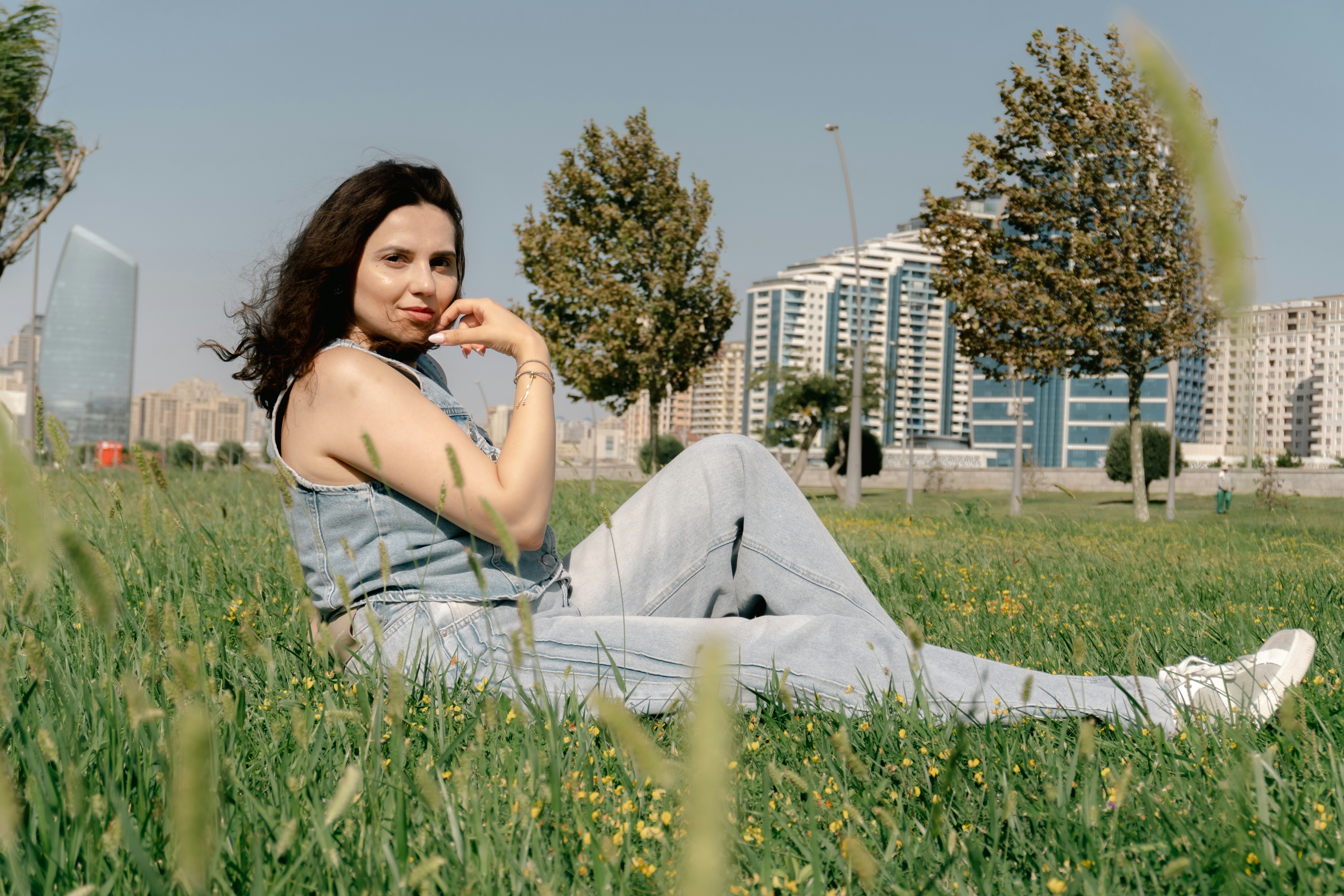 Sunlit Confidence: A Relaxed Portrait in a Green Urban Park