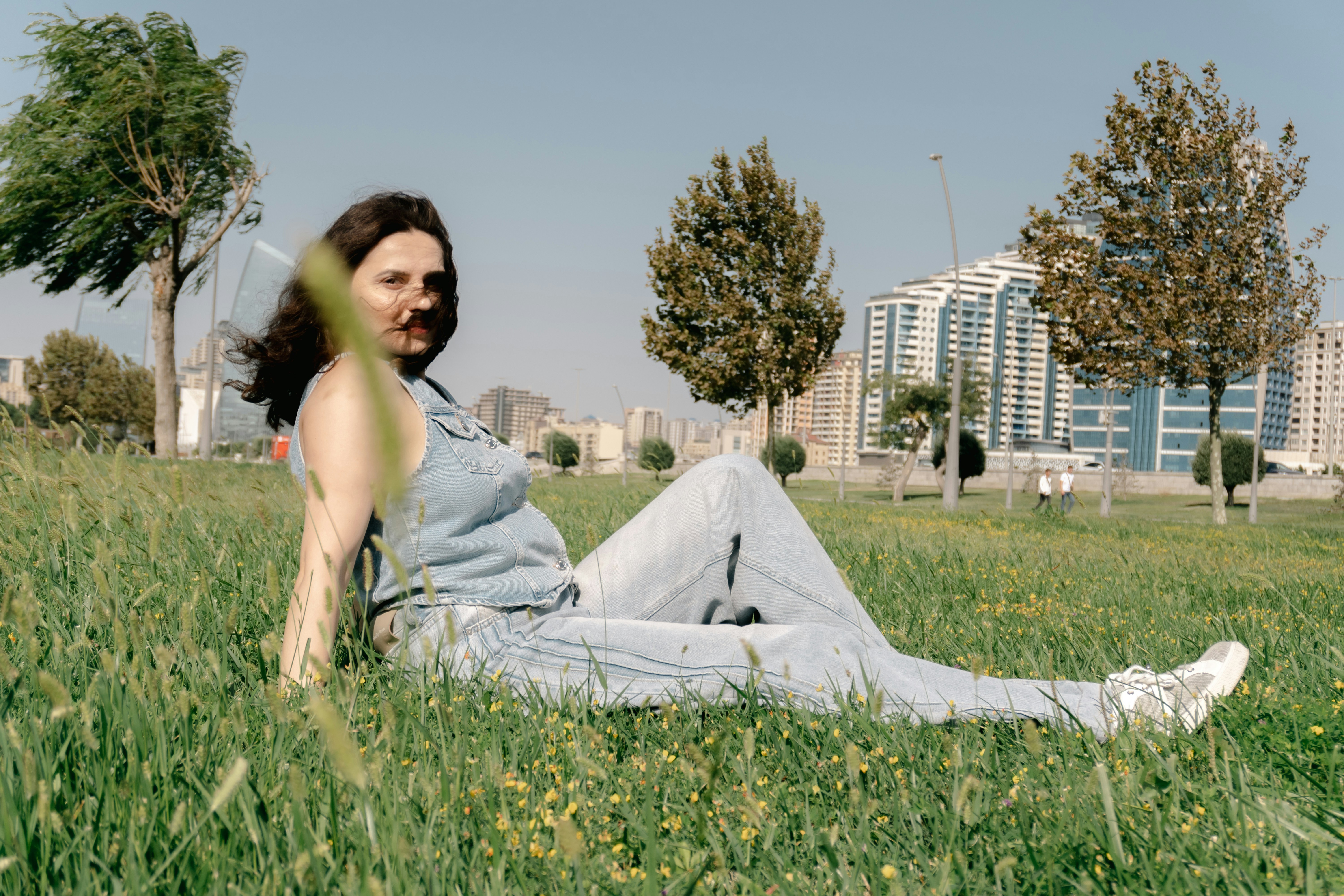 Lying In the Grass: A Quiet Moment Beneath Skyline Trees