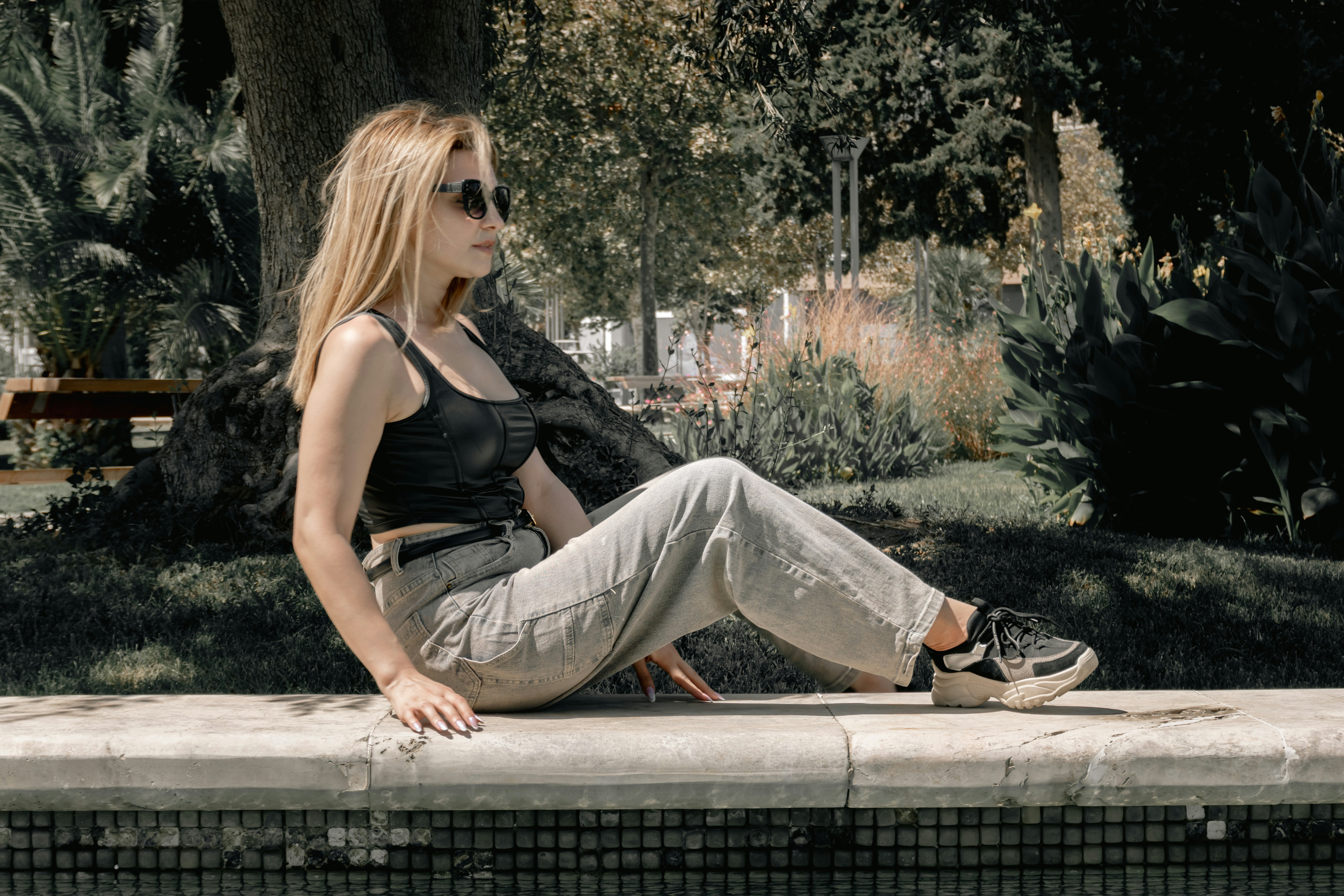 Sunlit Casual: A Seated Portrait by the Poolside
