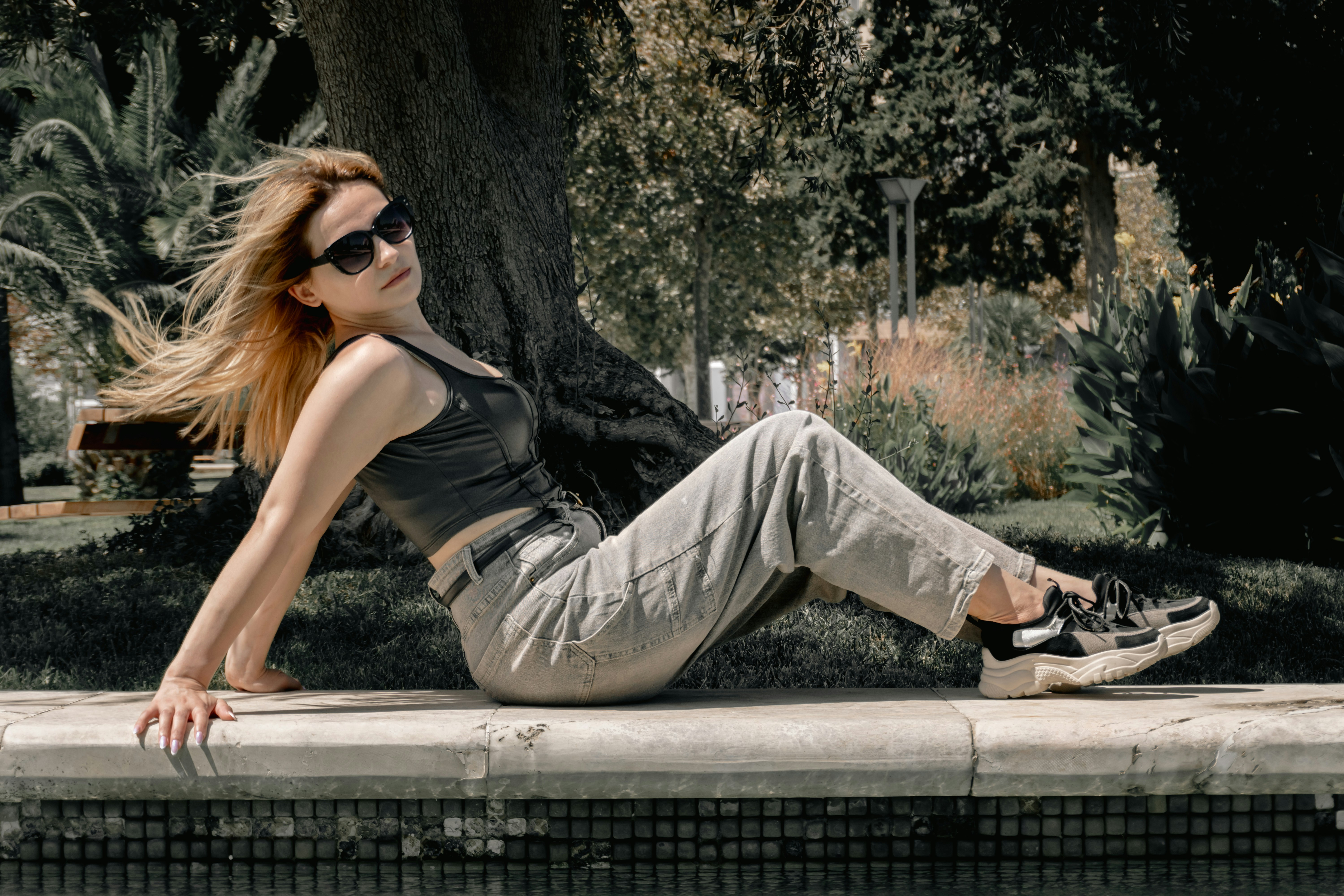 Casual power: a sunlit pose by the park edge