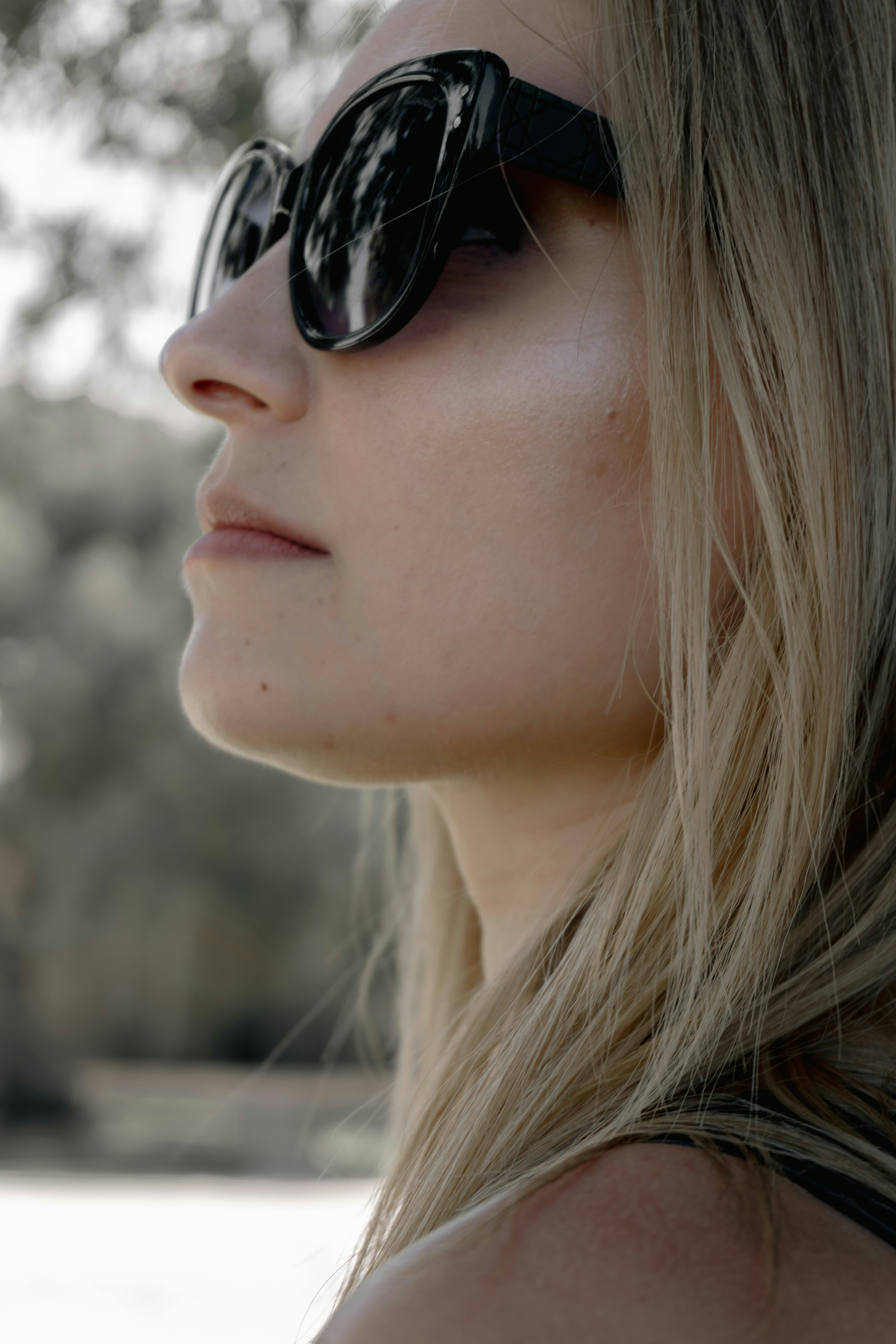 Sunglassed Gaze: Side Portrait in Soft Outdoors