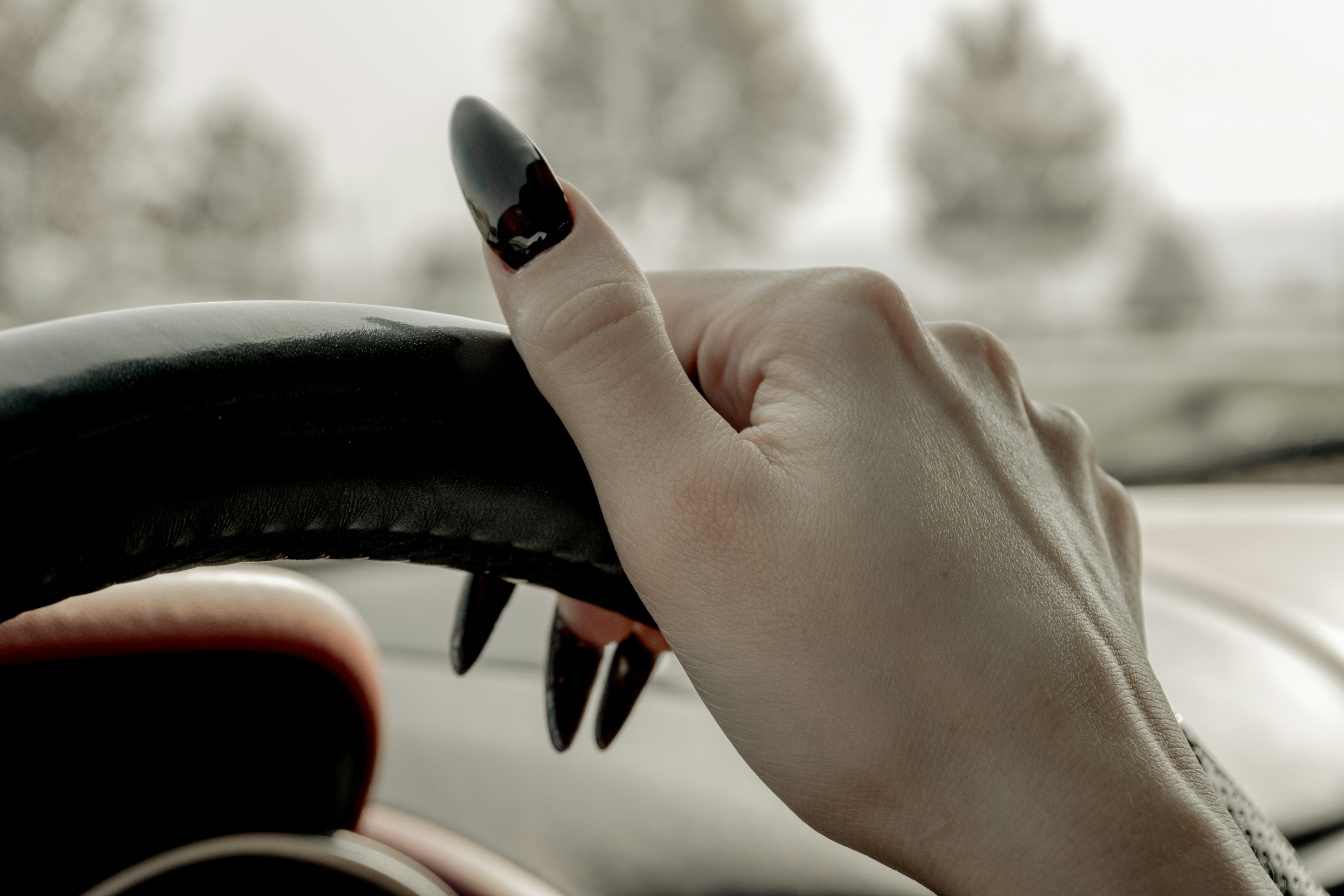 Gripped Moment: A Close-Up on the Steering Hand