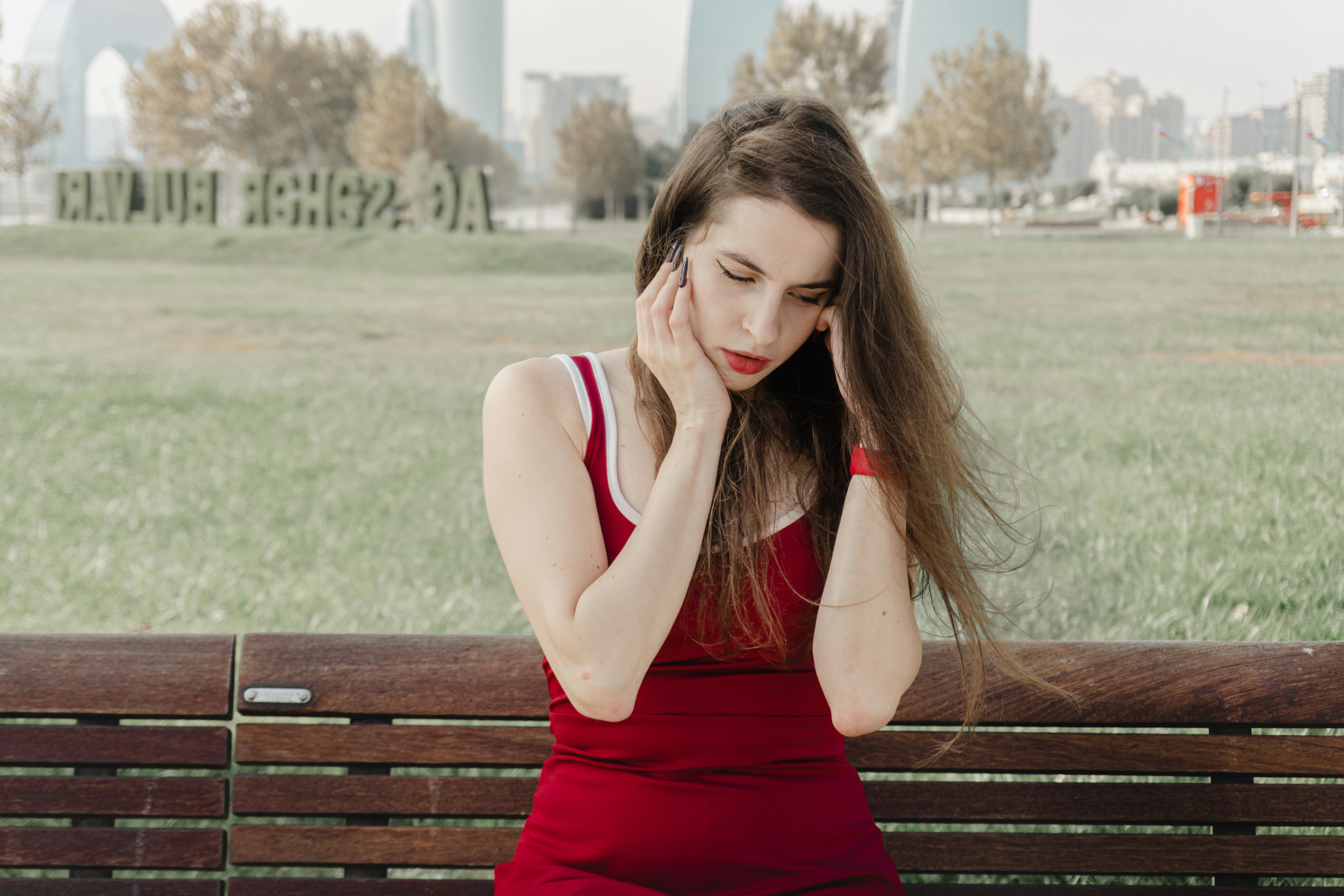 Red-dressed Solitude on a Park Bench