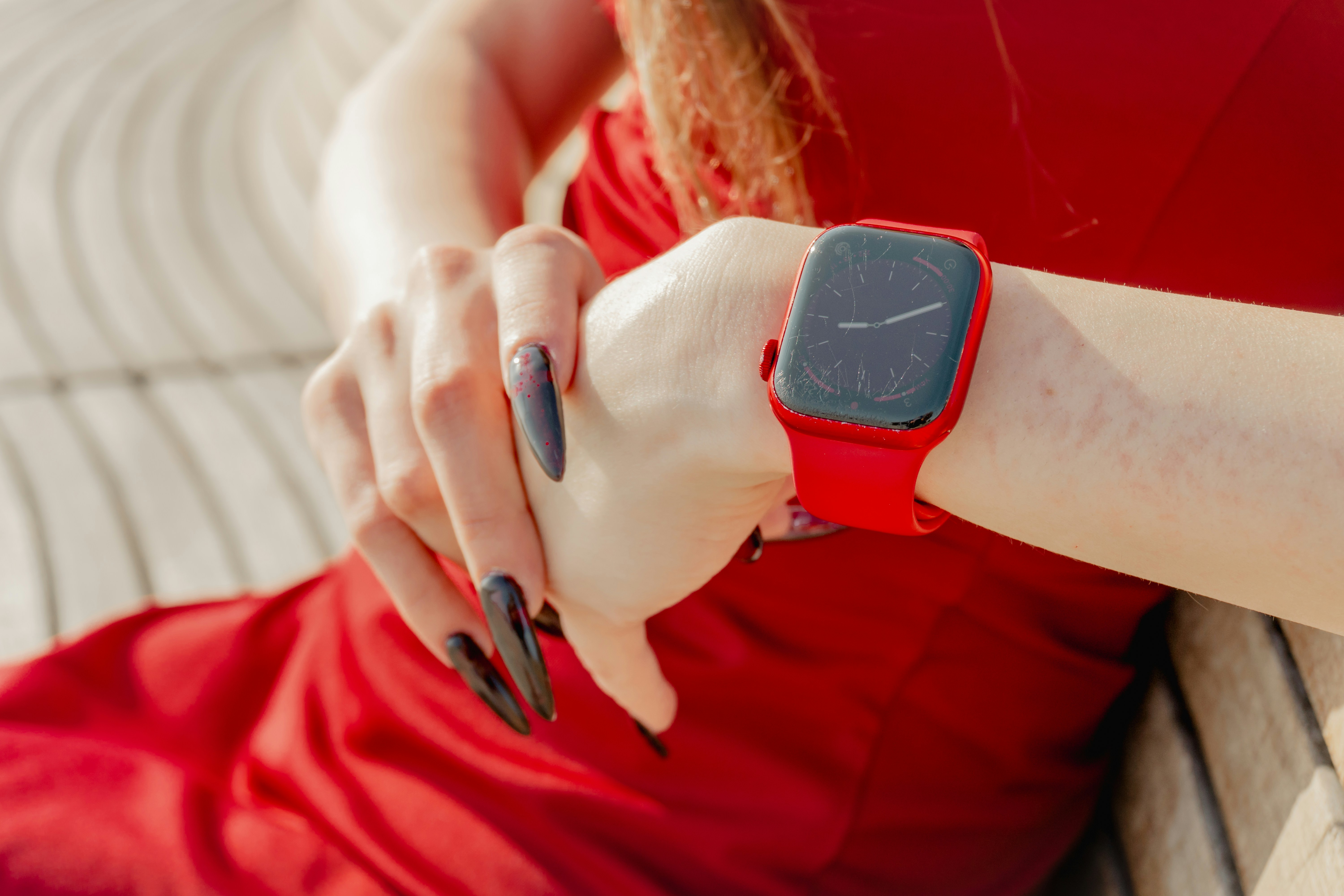 Red Hour: A Close-Up of a Wrist with a Bold Red Smartwatch