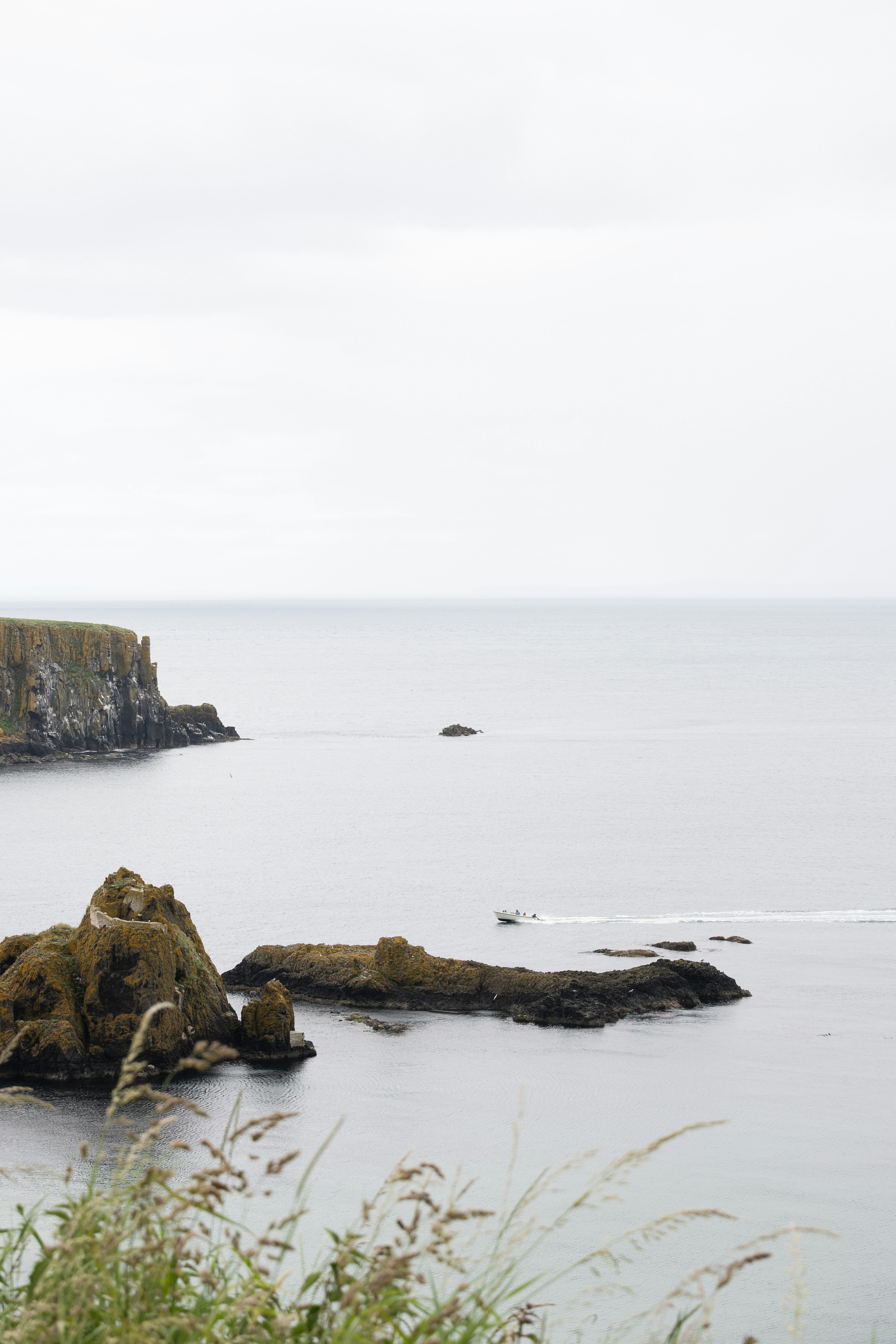 Cliffside Inlet: Quiet Sea and Outcroppings Under Soft Light