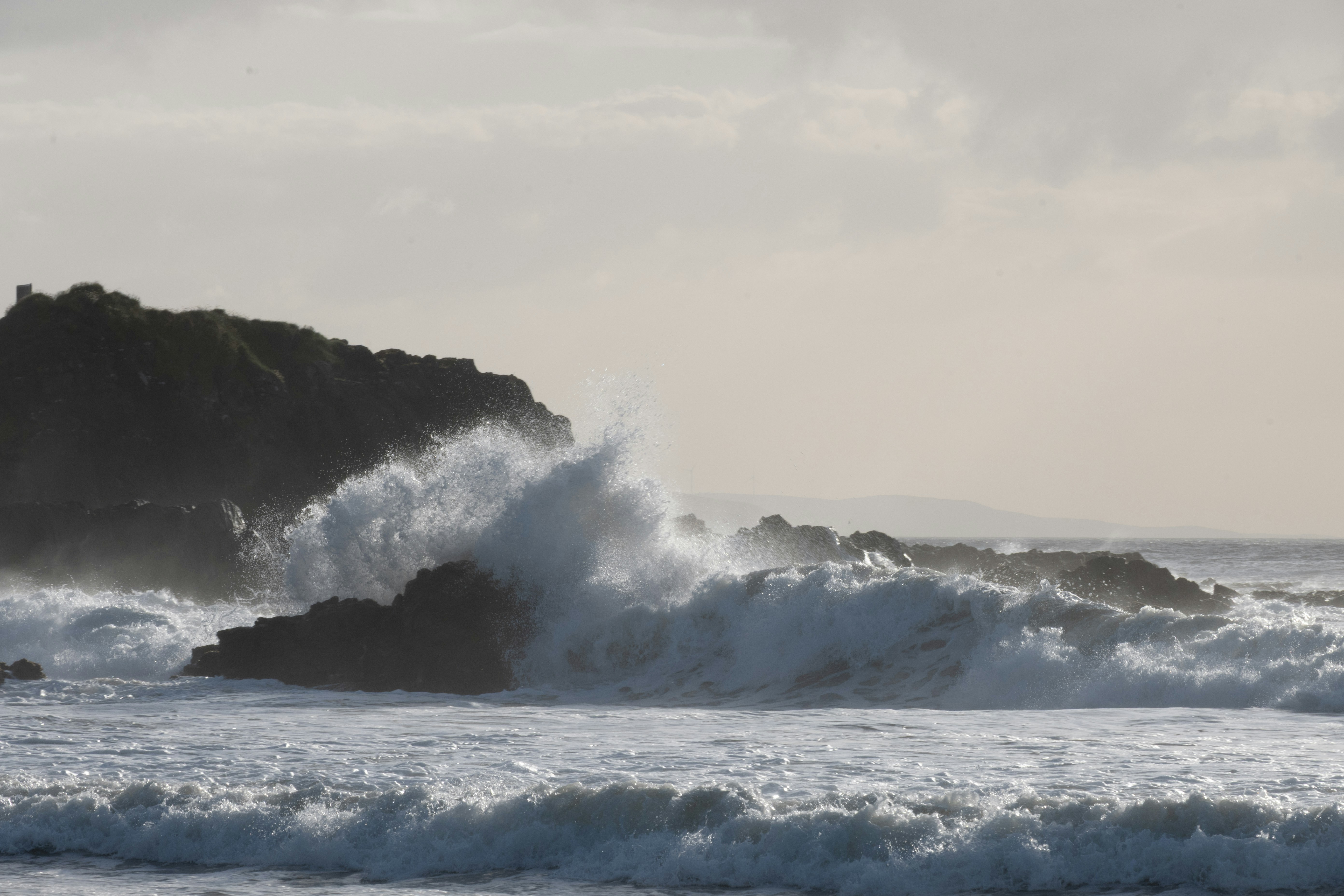 Coastal Crest: A Breaker's Quiet Power Against the Cliff