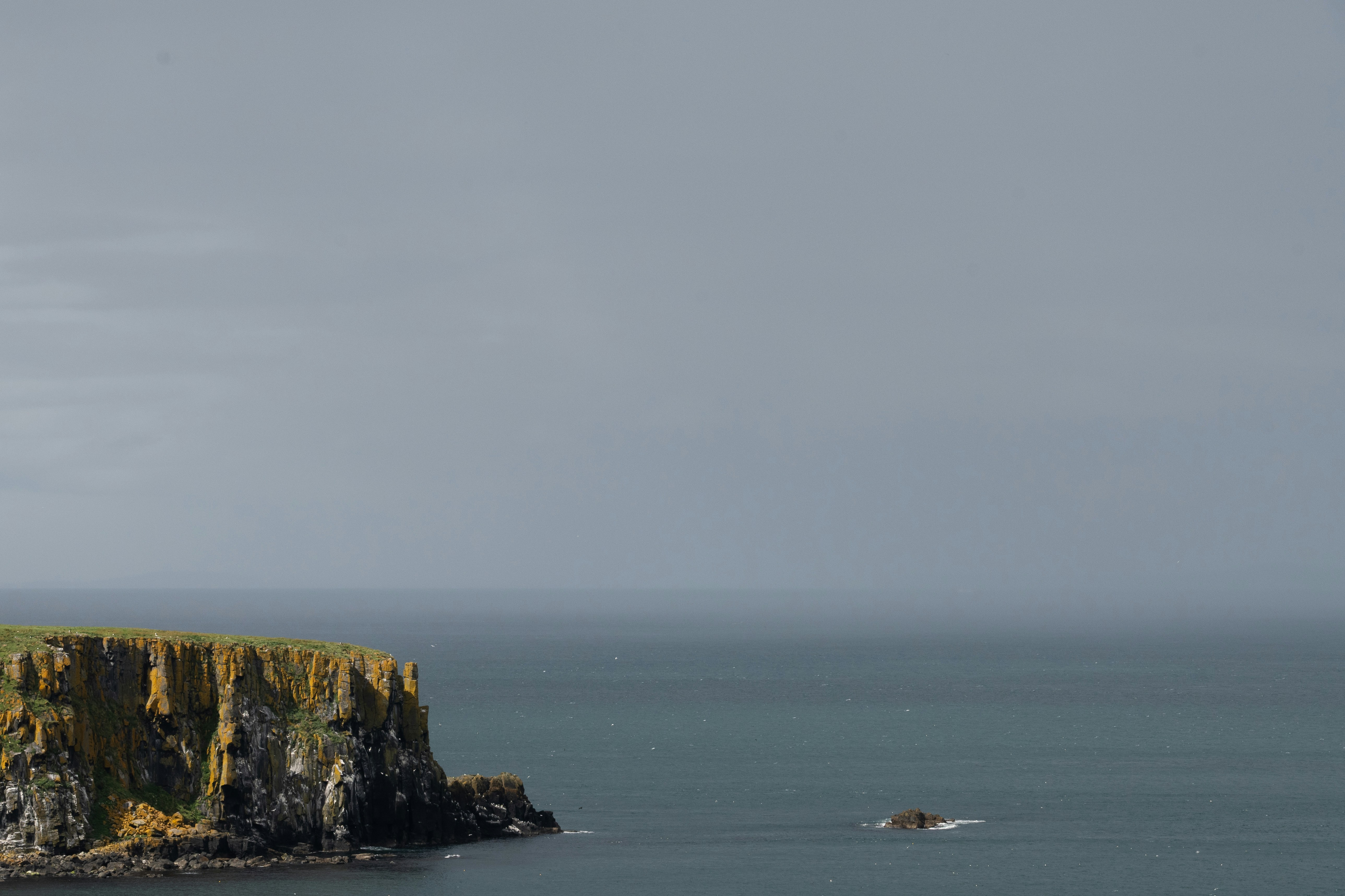 Storm-kissed Cliffline Over a Calm Sea