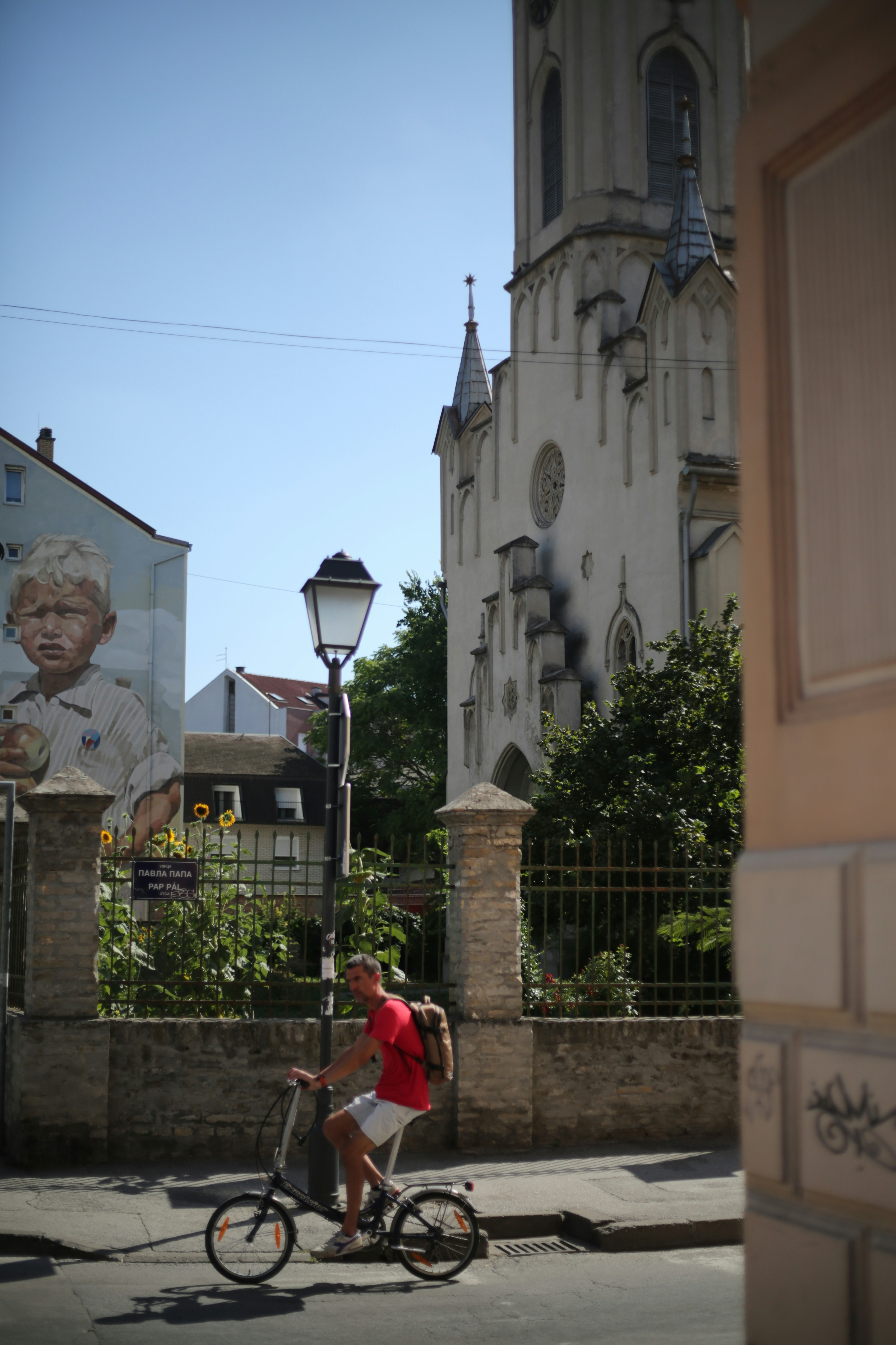 Biker in the Shadow of a Gothic Steeple
