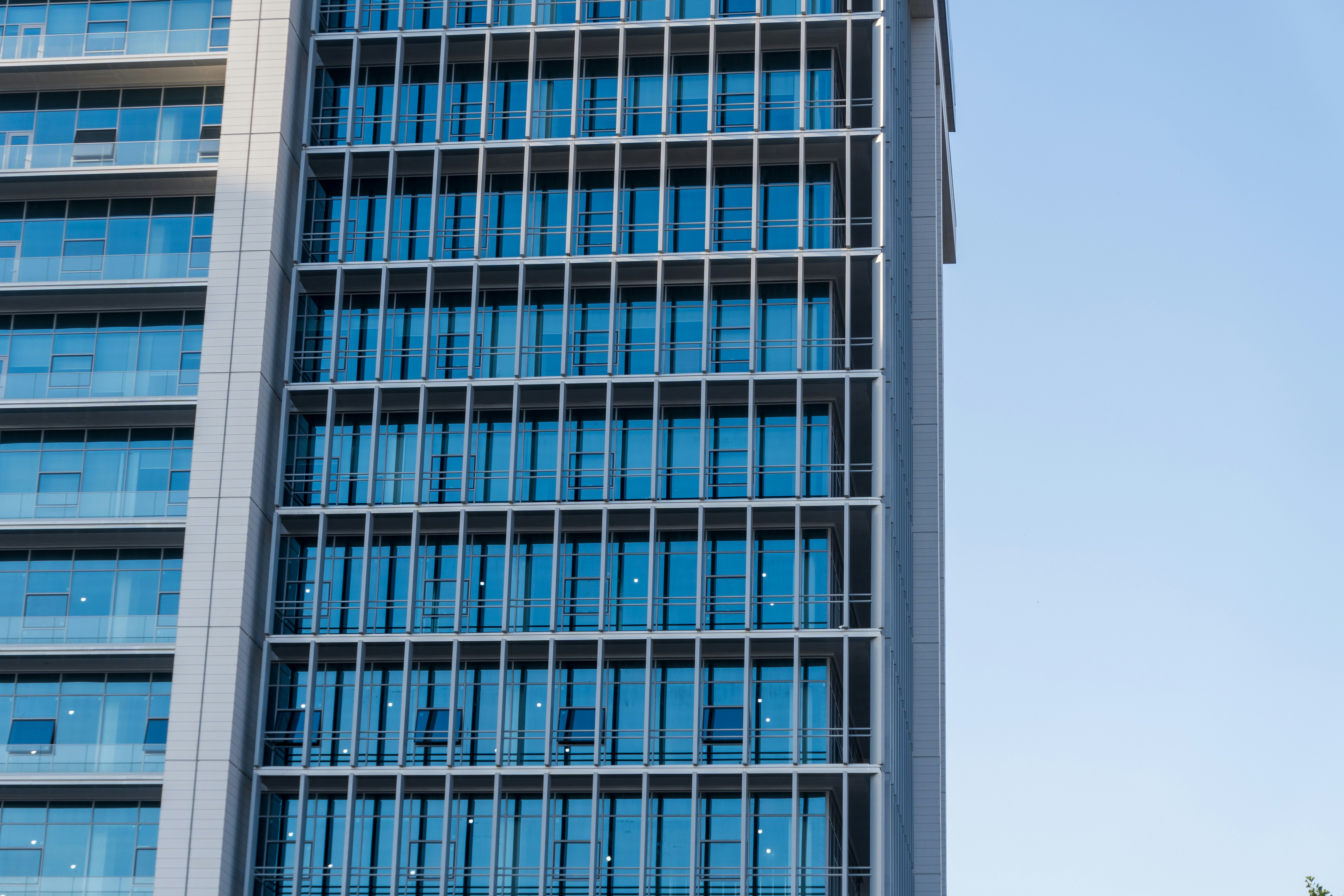 Gridline Symphony: Facades Reflect the Sky Against a Modern Tower