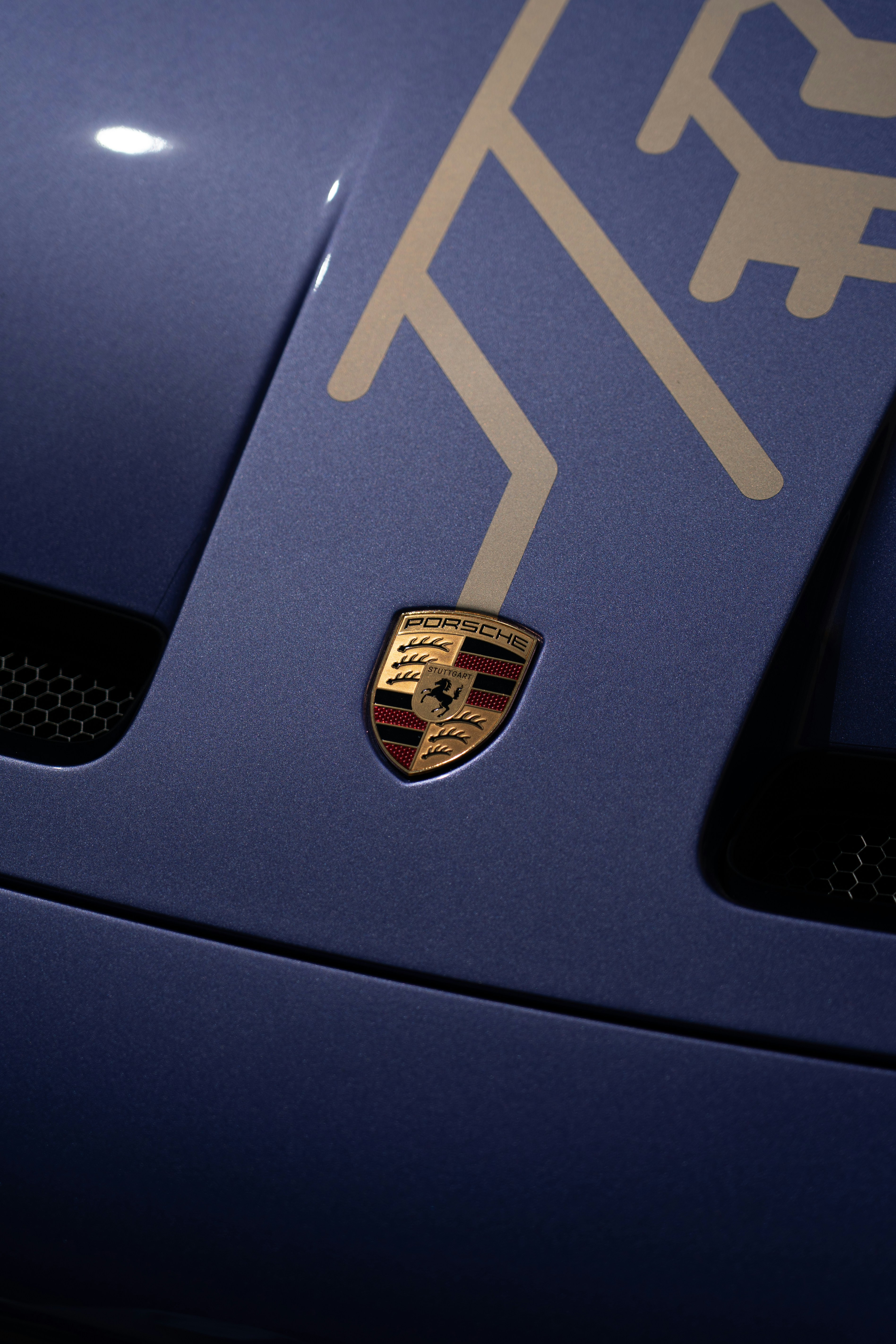 Emblem in Focus: Porsche Shield Centered Between Car Grilles