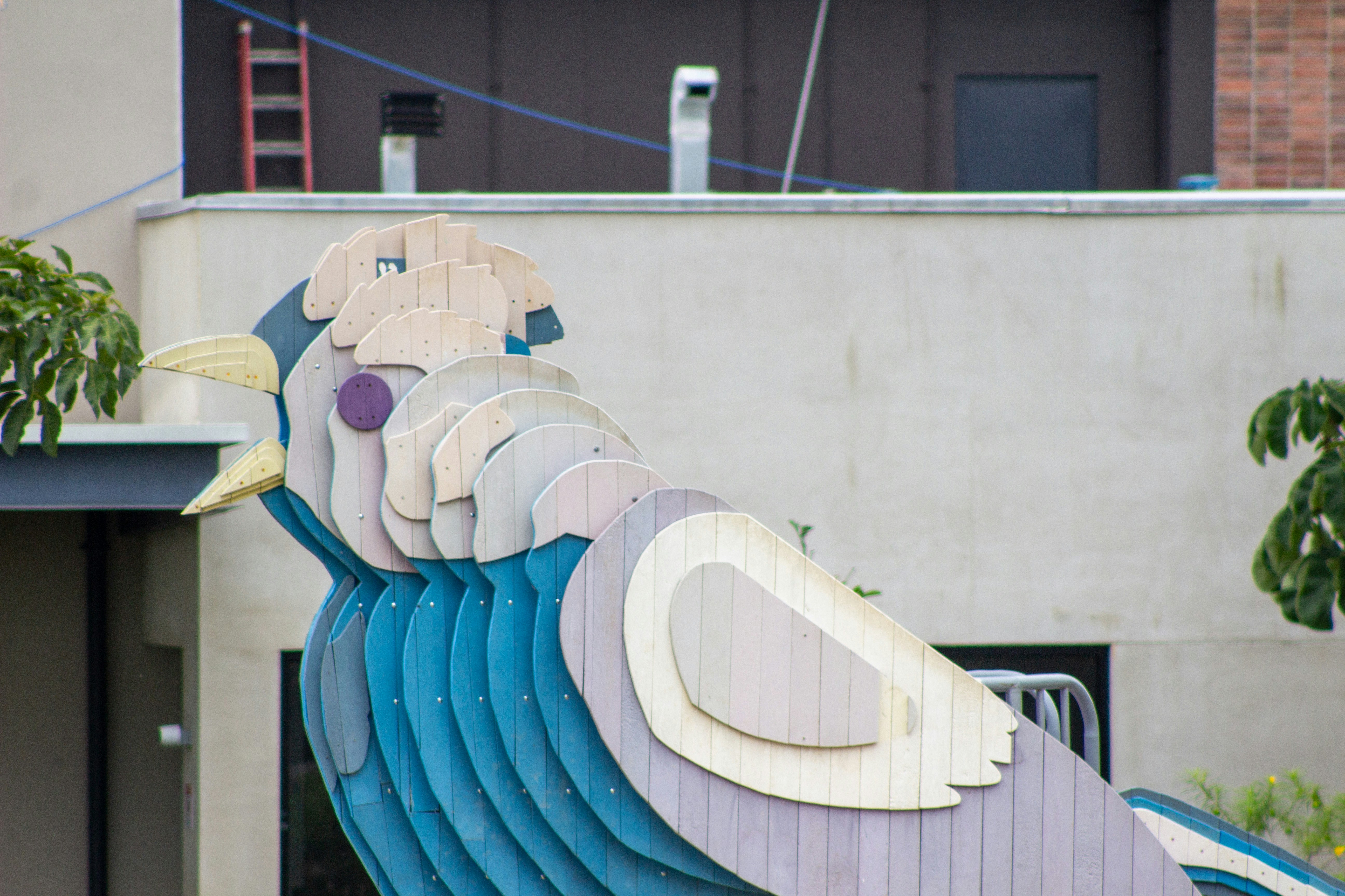 Colorful cardboard sea serpent spiraling toward the sky