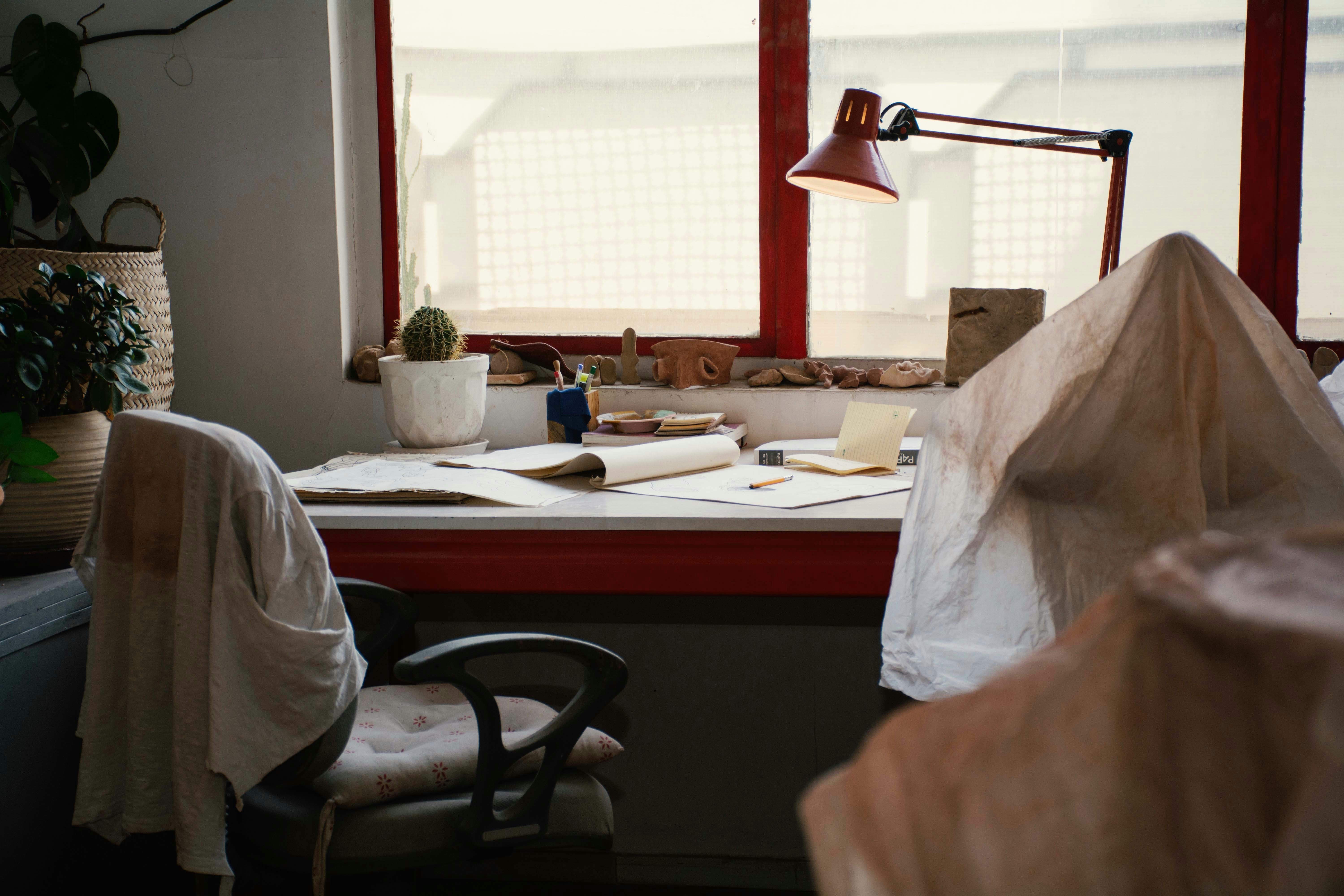 Sunlit Desk Beneath Red-Framed Window