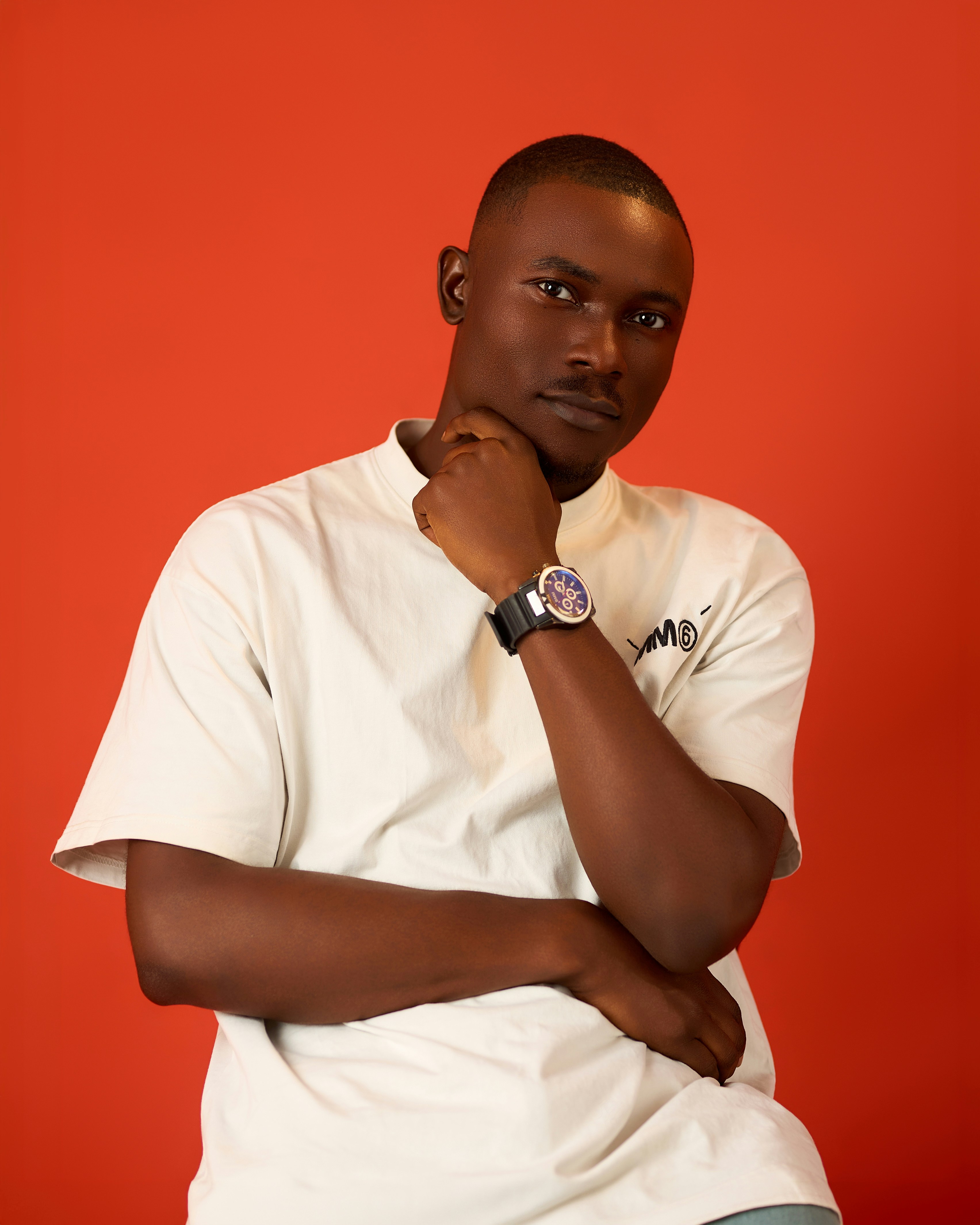 Portrait in Warm Orange: A thoughtful pose with watch as focal accent
