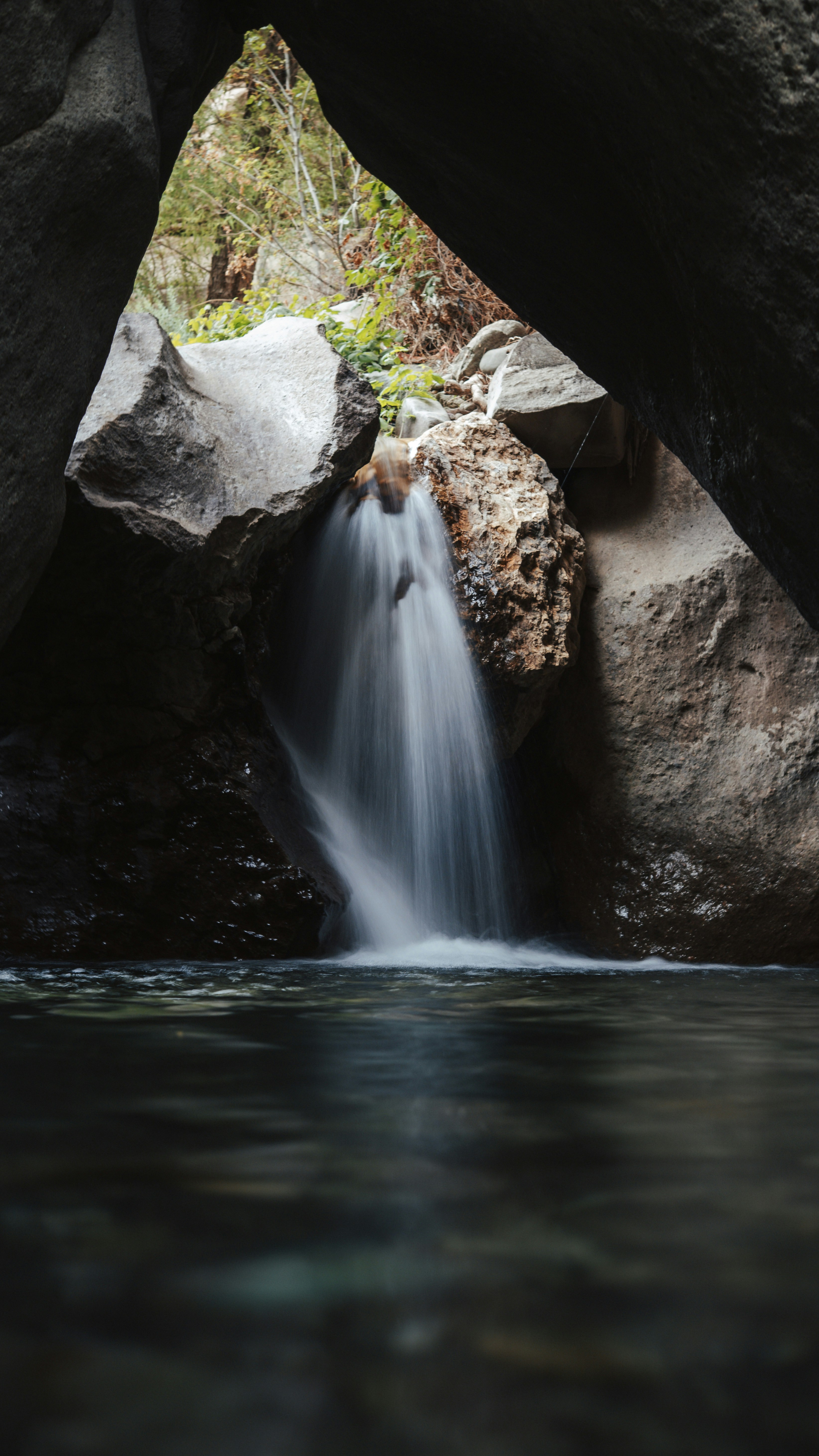Hidden Cascade Through a Stone Arch