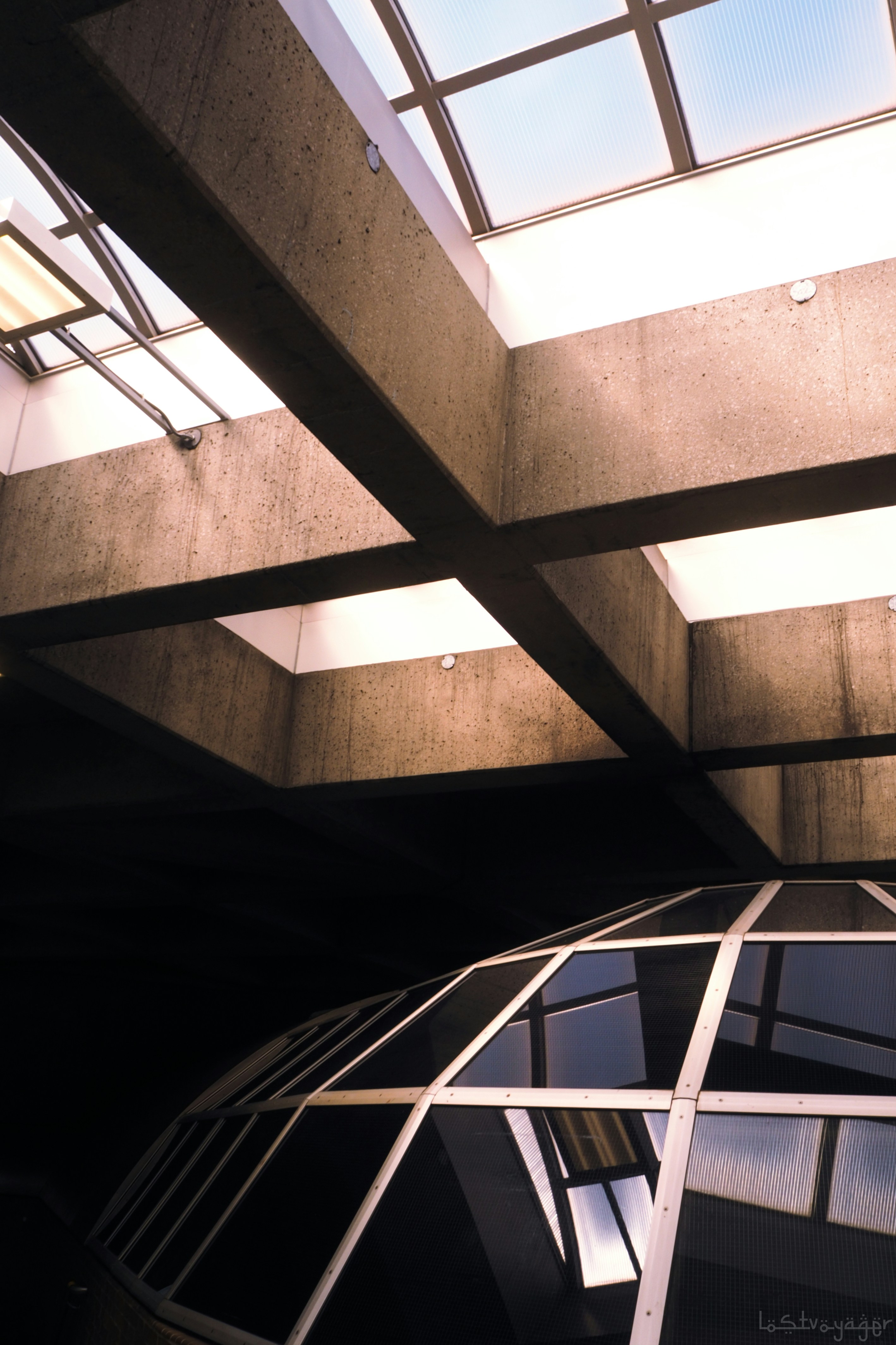 Geometric Light: Concrete Beams and Glass Dome Meet