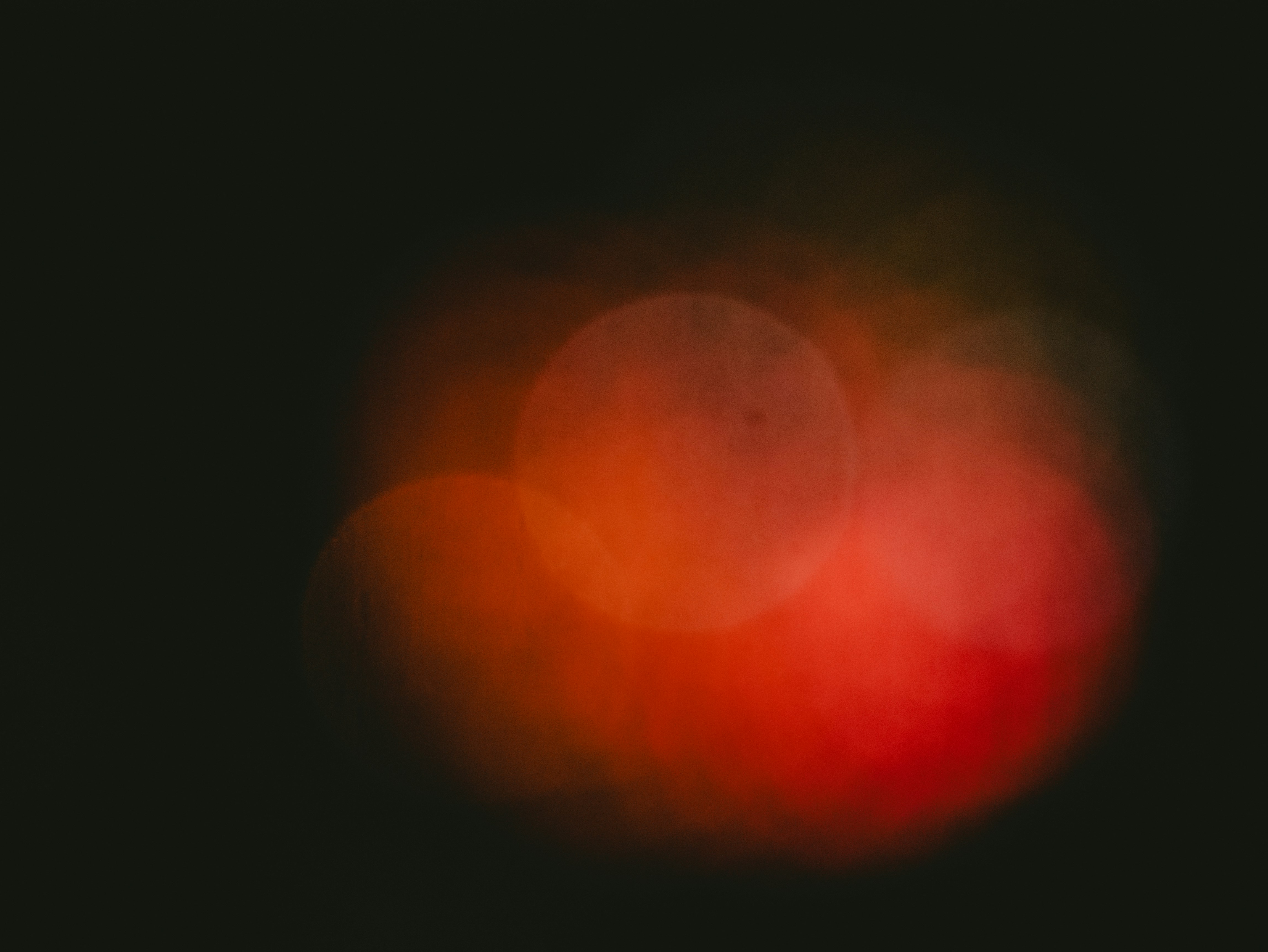 Soft Fire: Blurred Orbs Laughing in the Dark