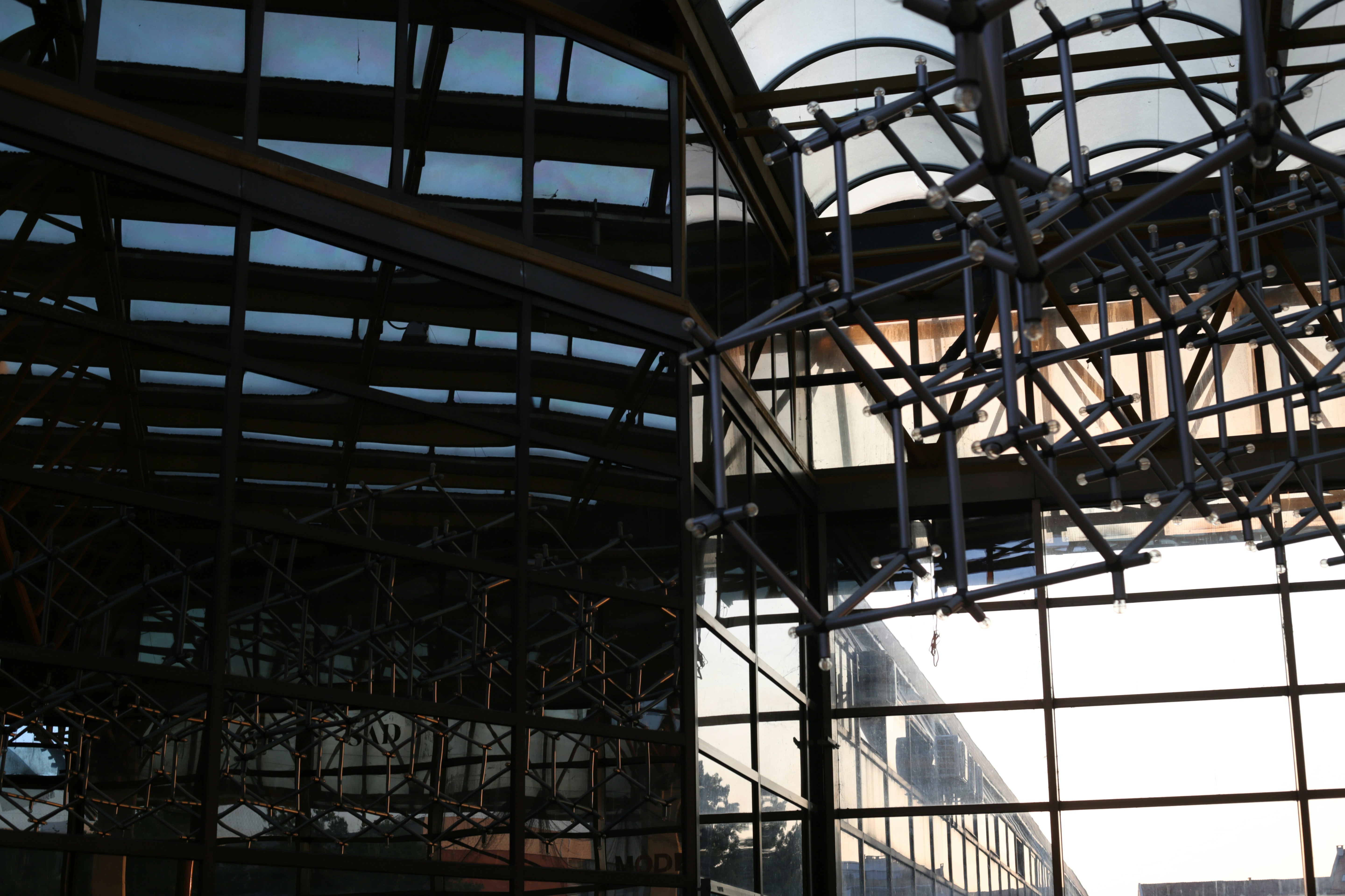 Crisscrossed Rails and Glass: An Architectural Tangle at Dusk