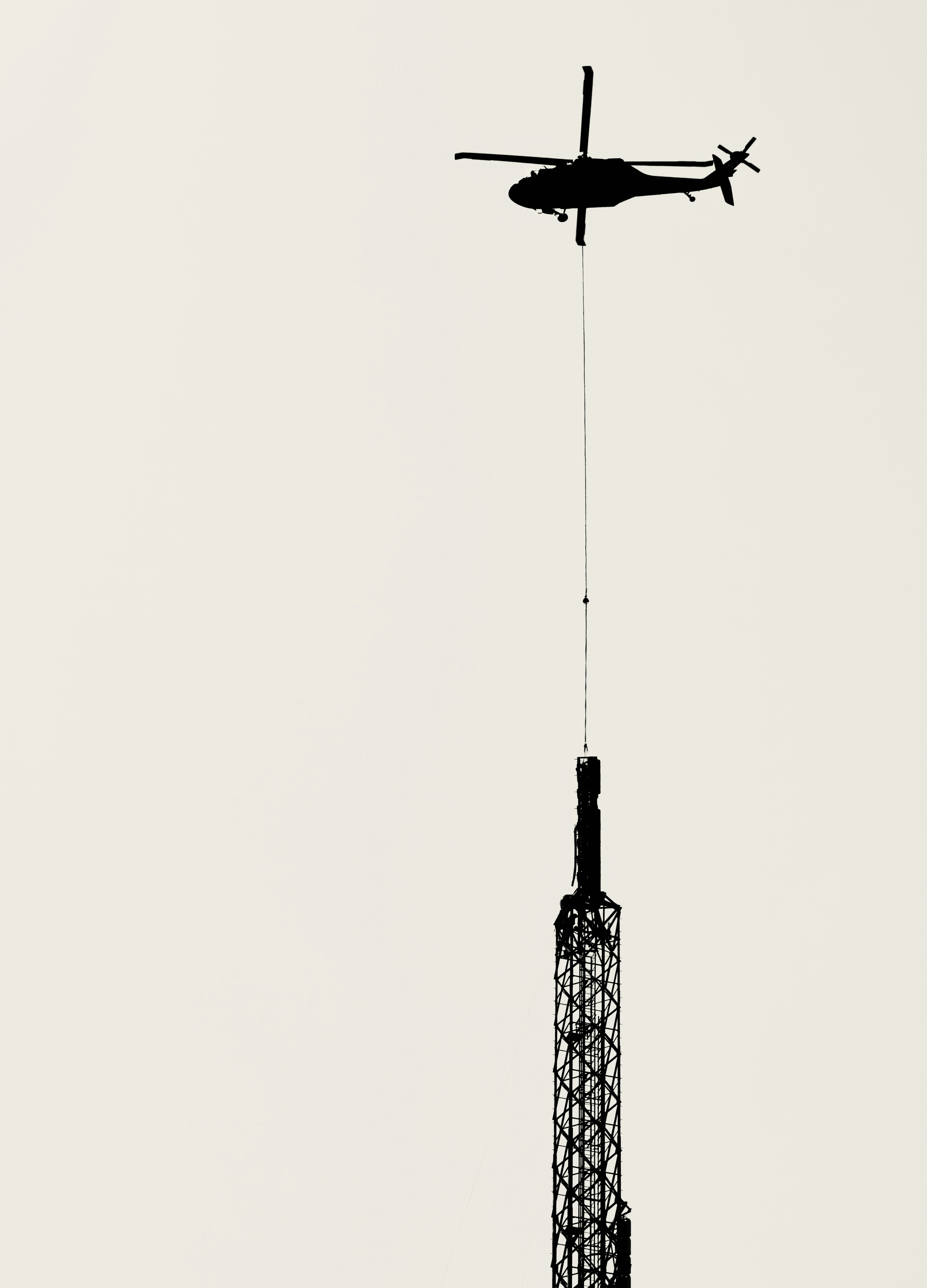Rising Helix: A Crane-Tethered Helicopter Elevates a Communication Tower