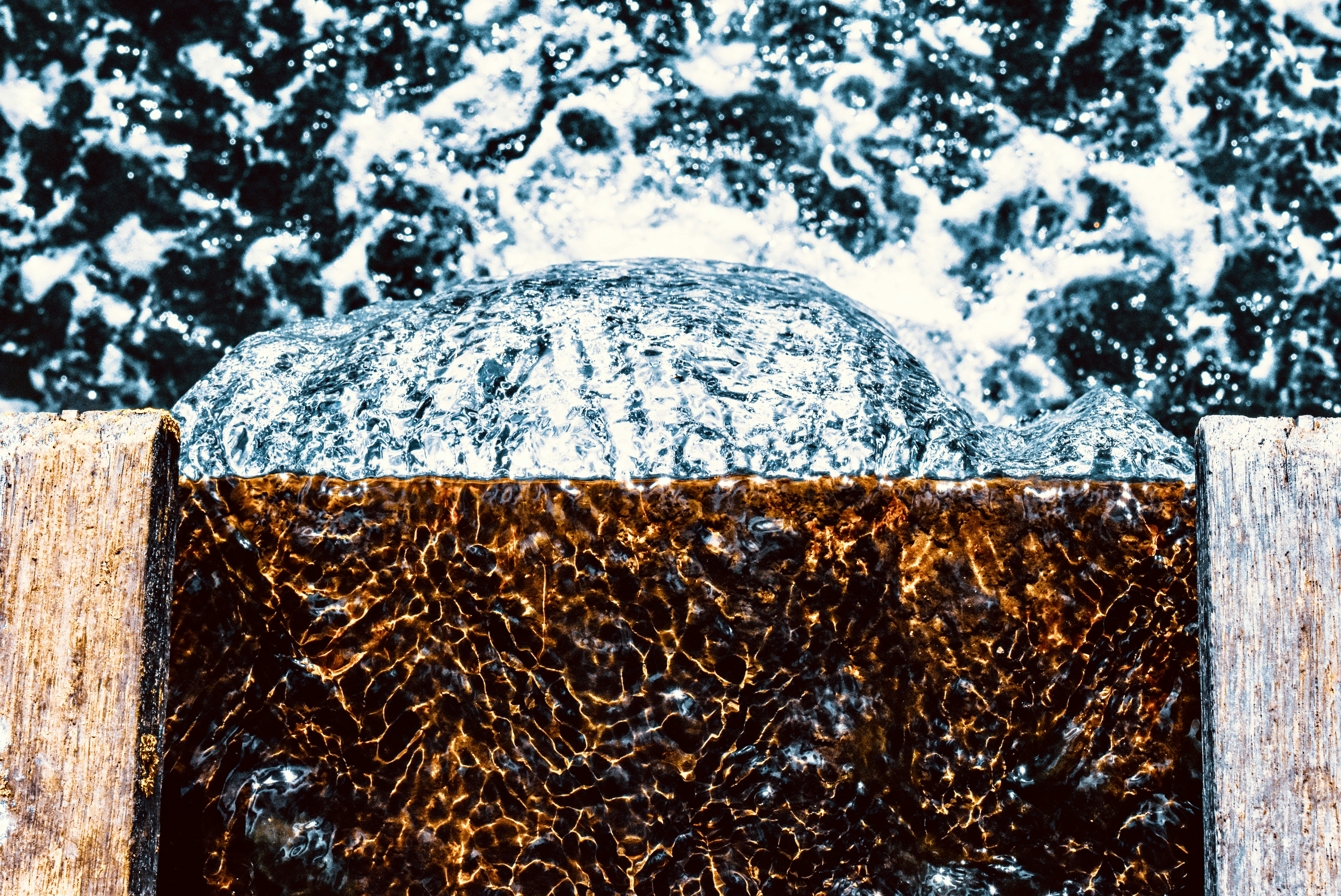 Stone Eye of the Pier: A Cropping Moment Over Ocean Plunge