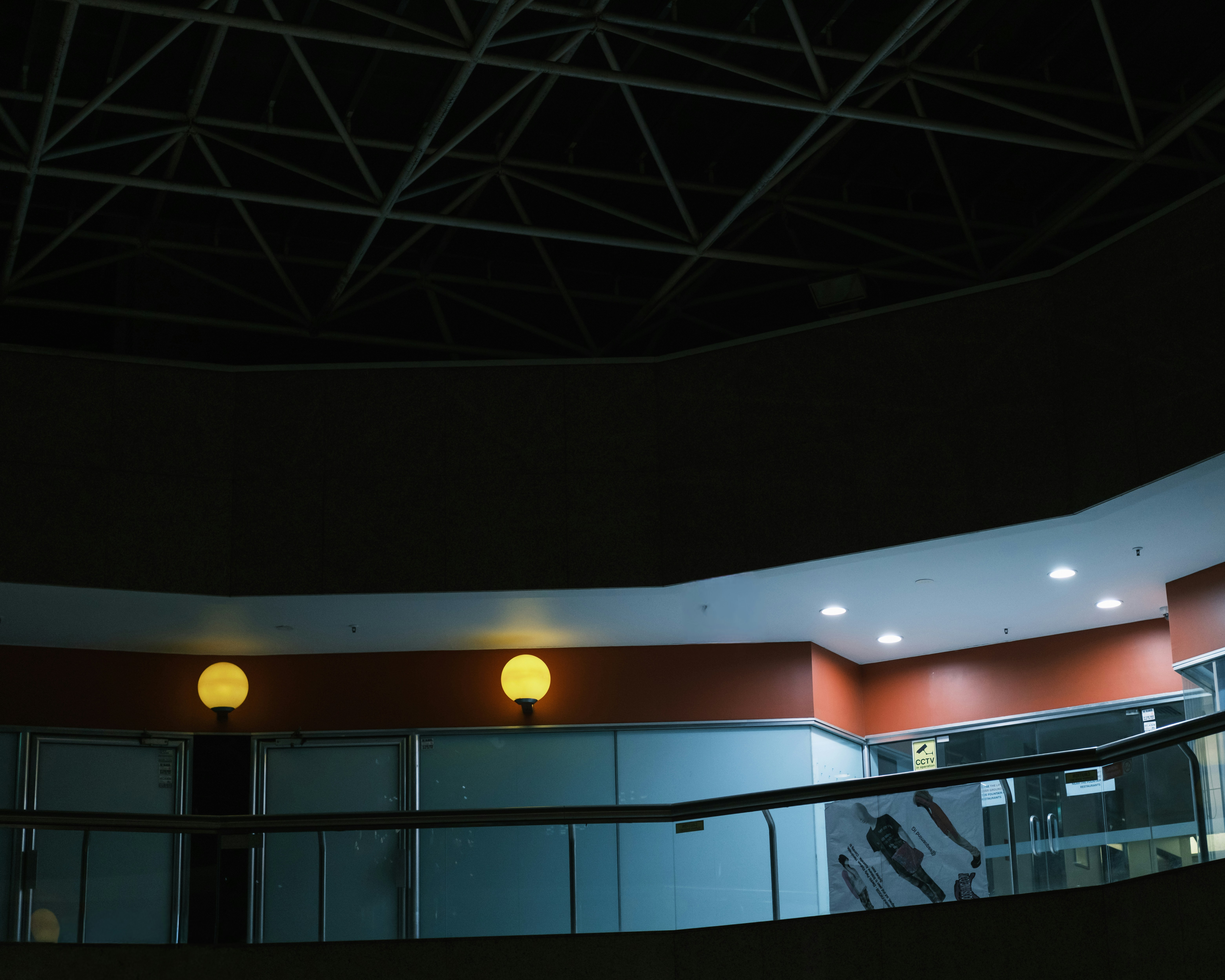 Curved Balcony Light: Quiet Atrium at Dusk