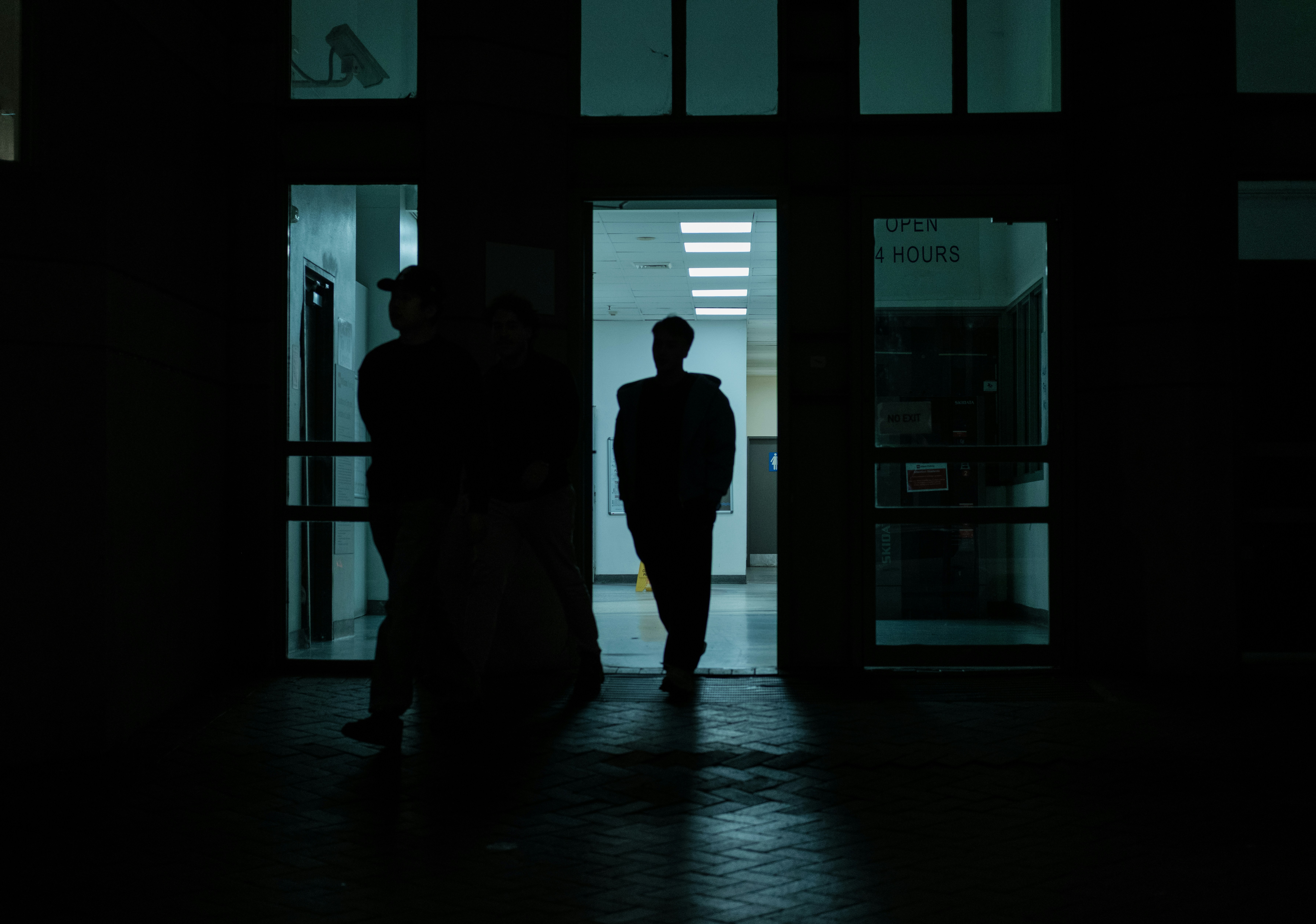 Midnight Corridor: A lone silhouette at the lit doorway
