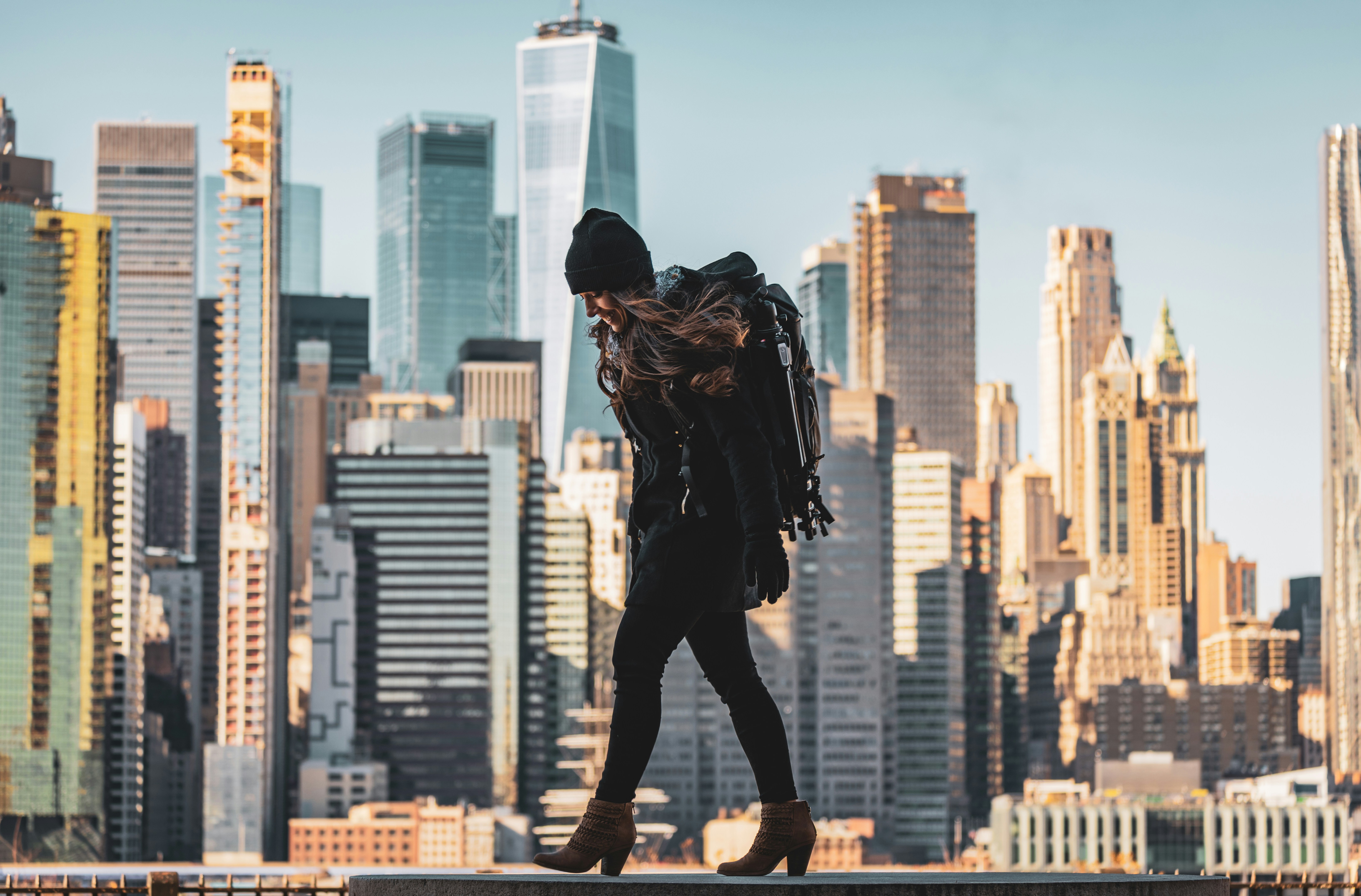 Cityscape Walker: A lone figure strides along the skyline