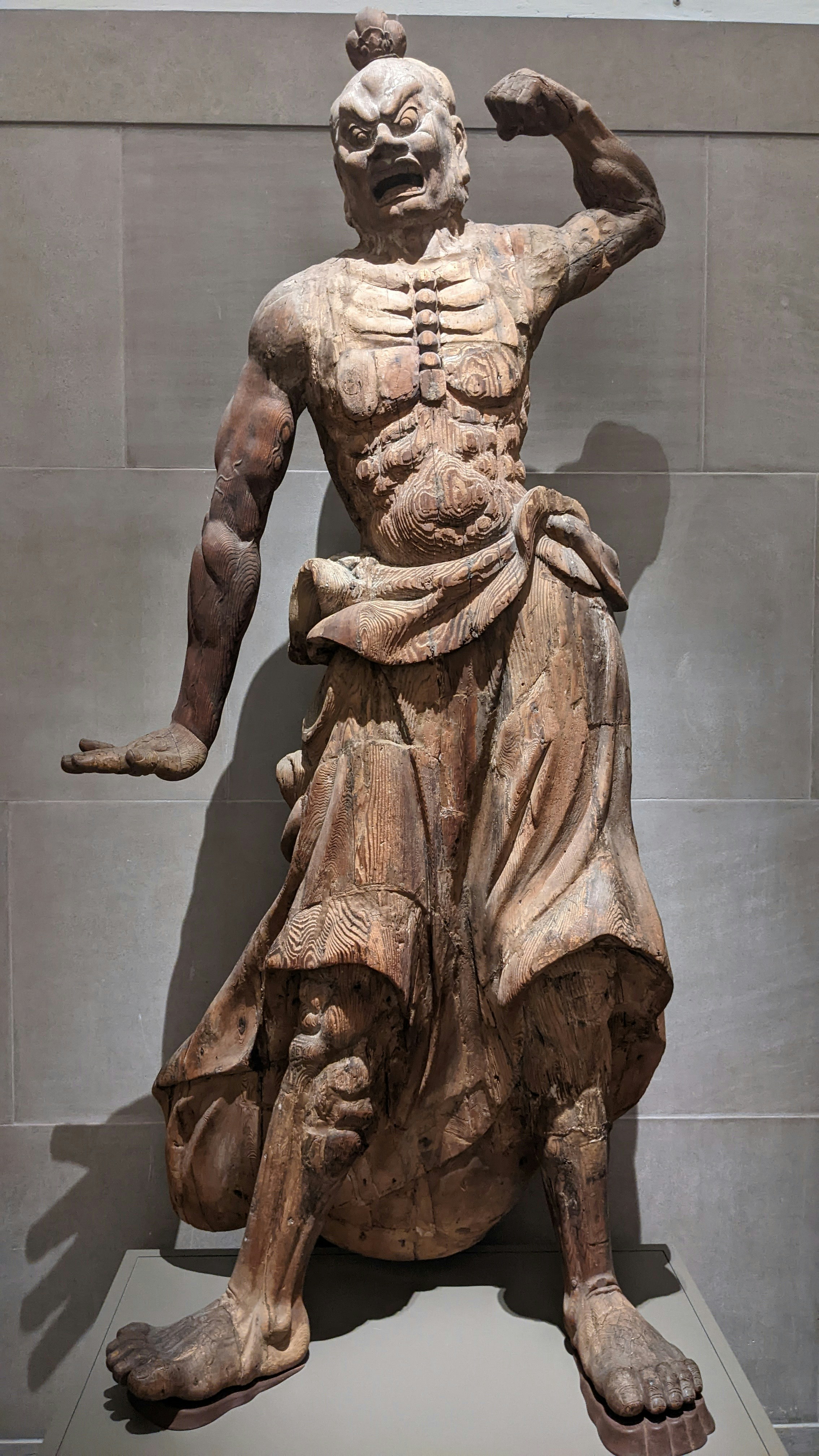 Relief Warrior in Stone: A Dynamic Pose from a Museum Pedestal