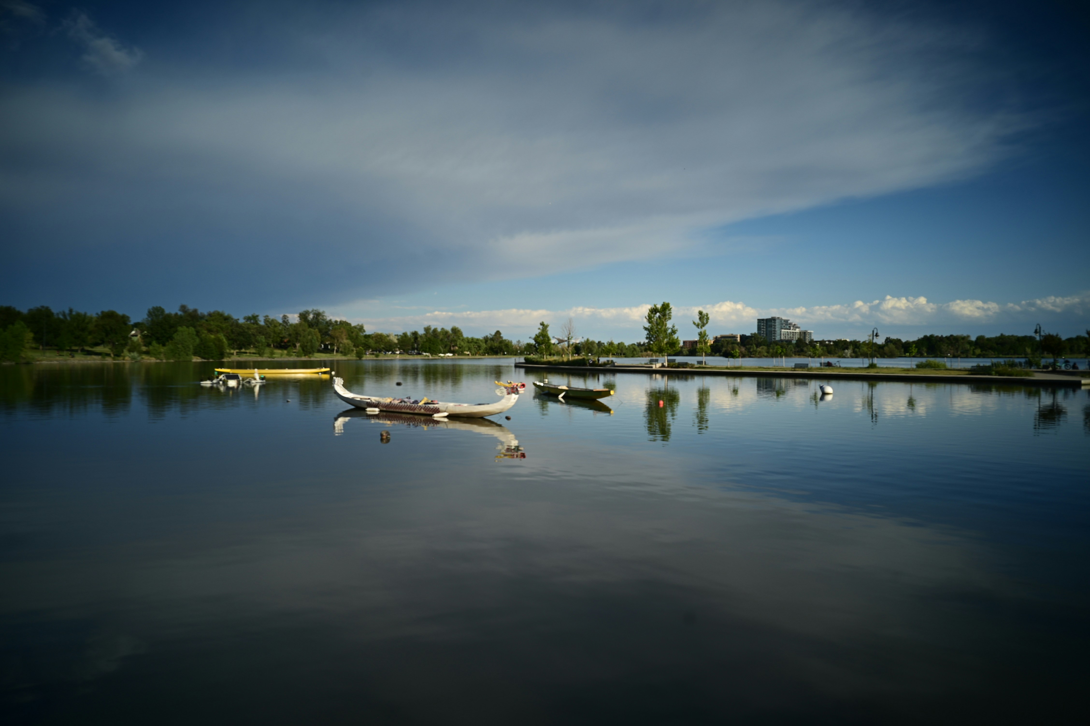 Floating Boats on a Serene Lake at Dusk