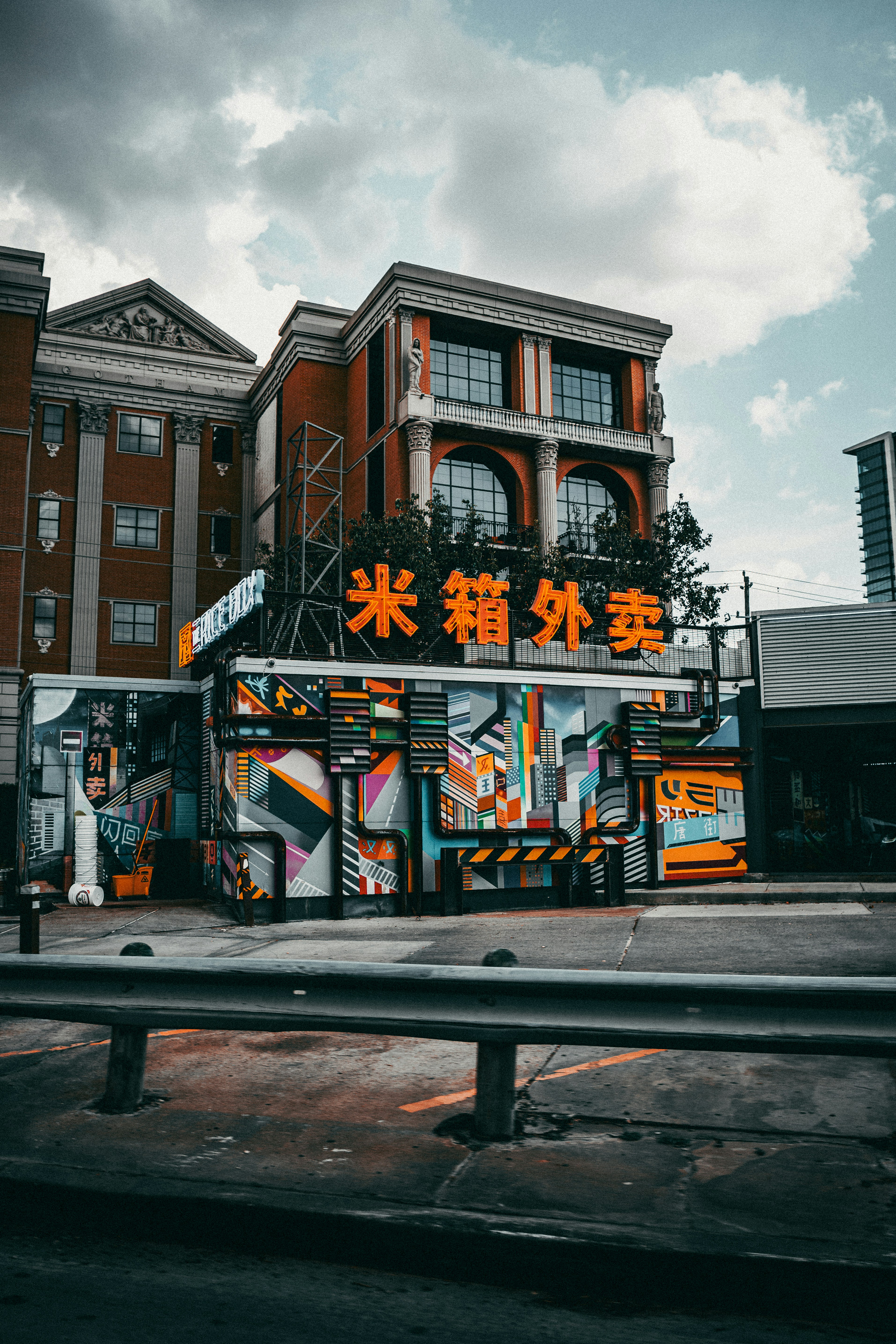 Neon Chinese Signage Over Color-Blocked Street Arcade