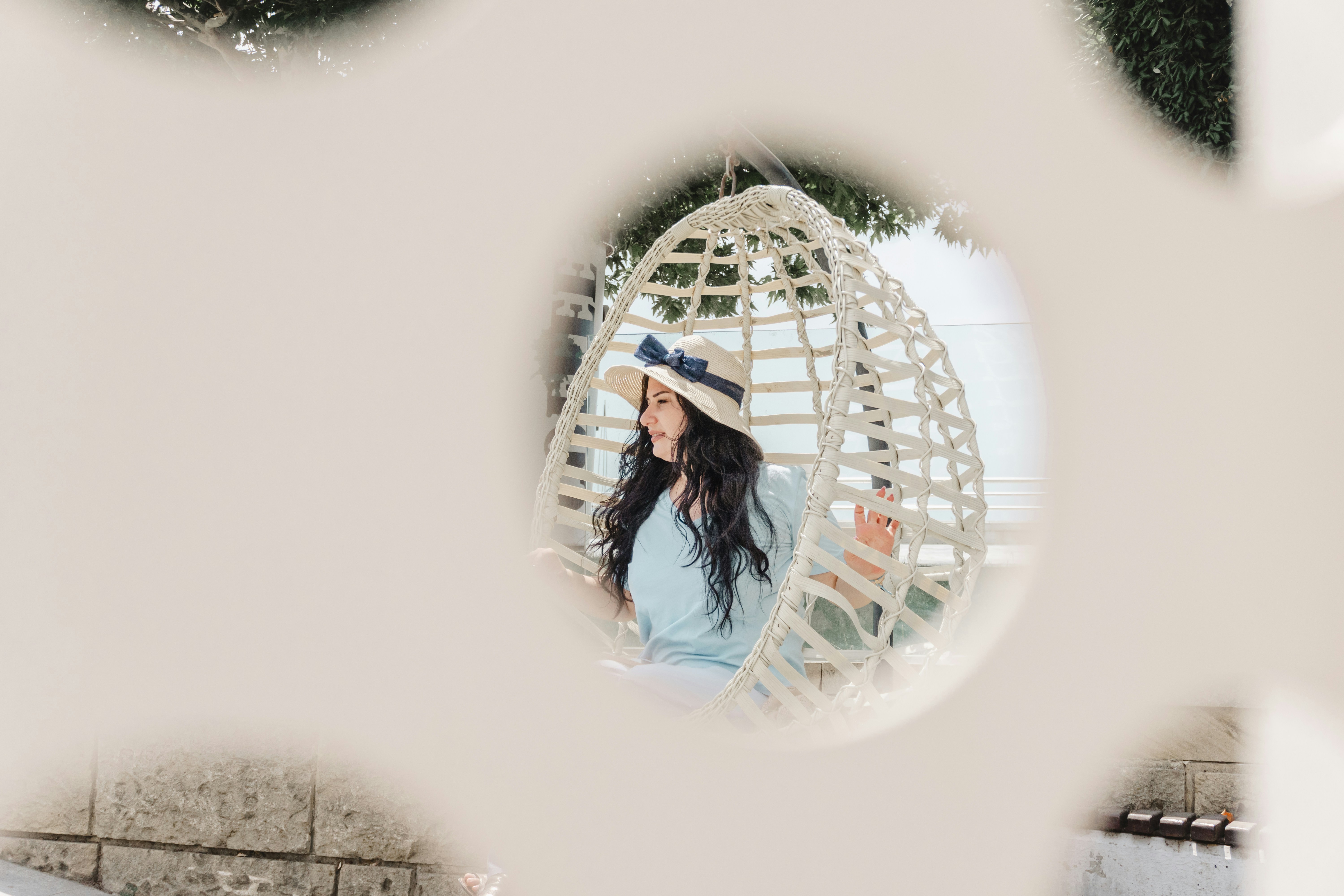 Hidden Portrait: A Woman in a Woven Dome Framed by Circular Apertures