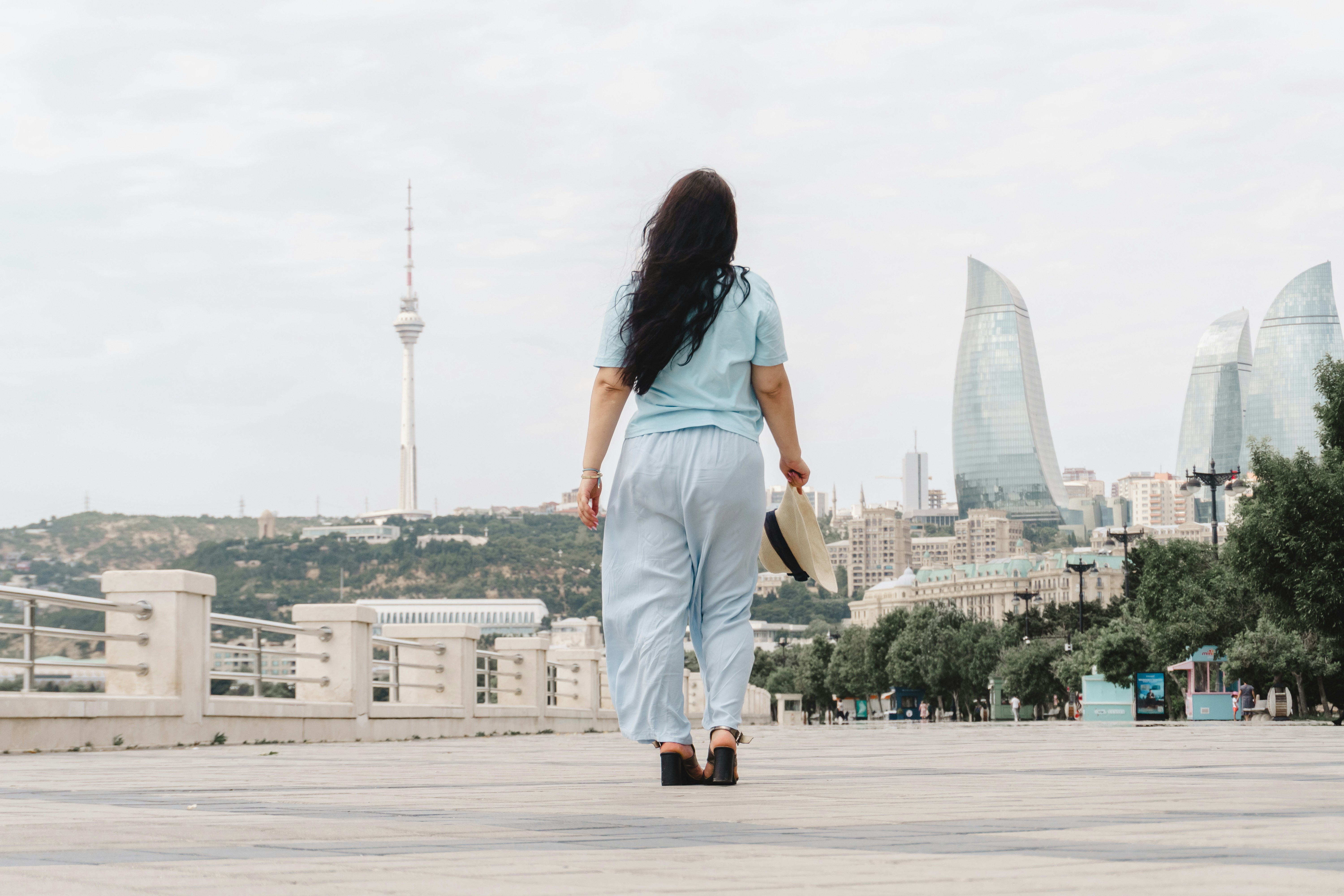 Citybound in Light Blue: A Lone Walk Toward the Skyline