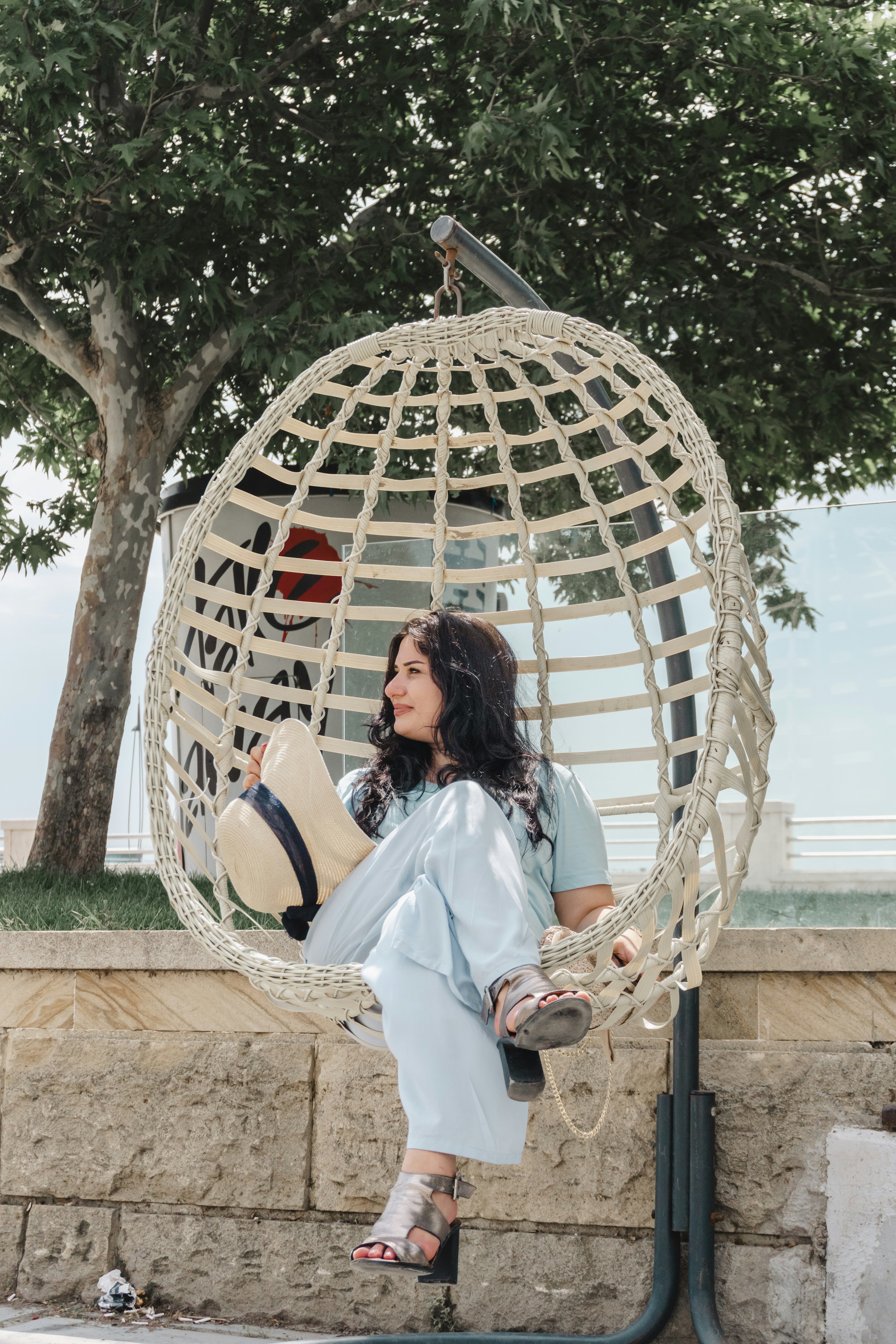 Relaxed Moment in a Rope-Sphere Garden Chair