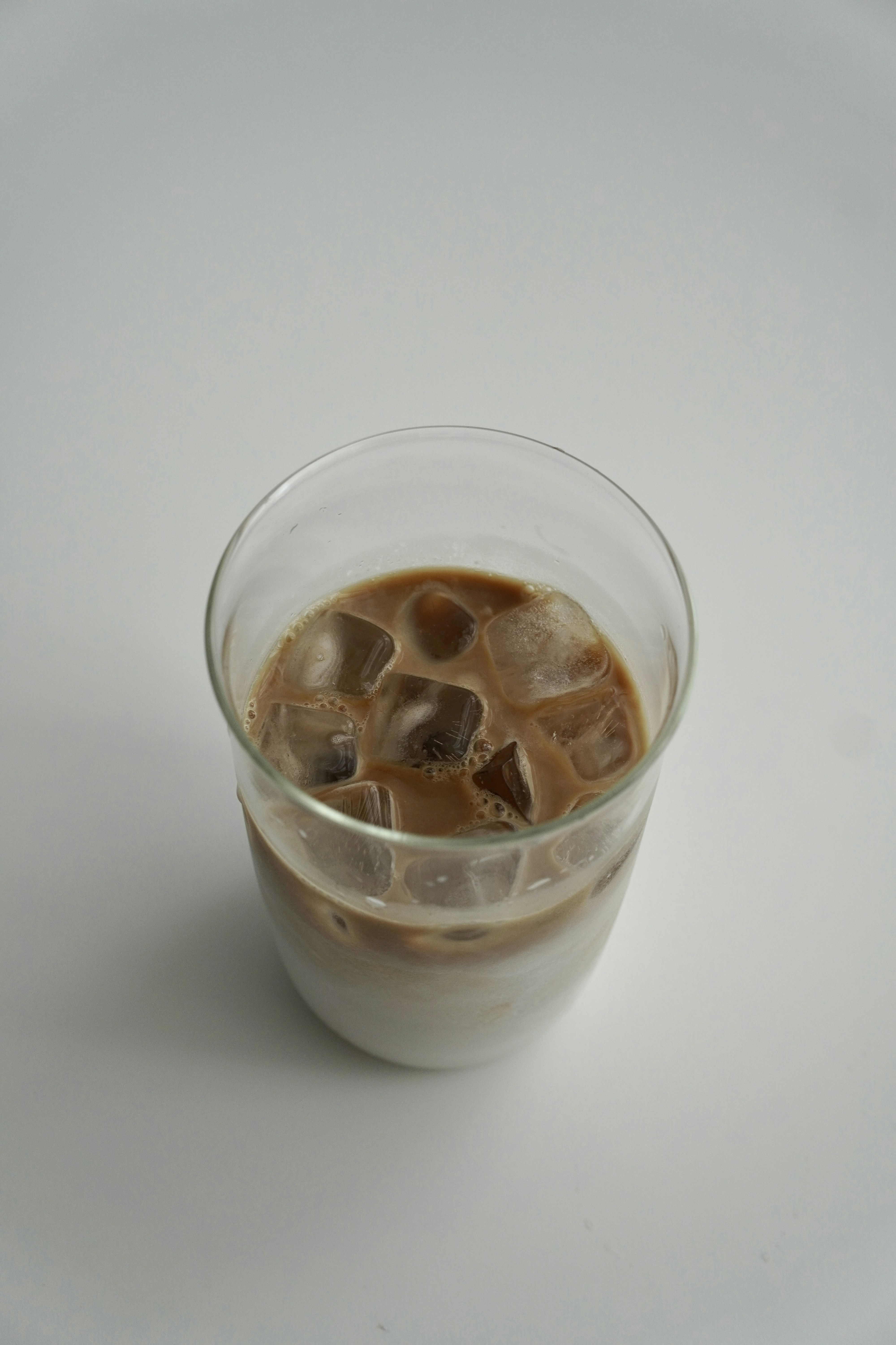 Iced latte in a tall glass: minimalist still life