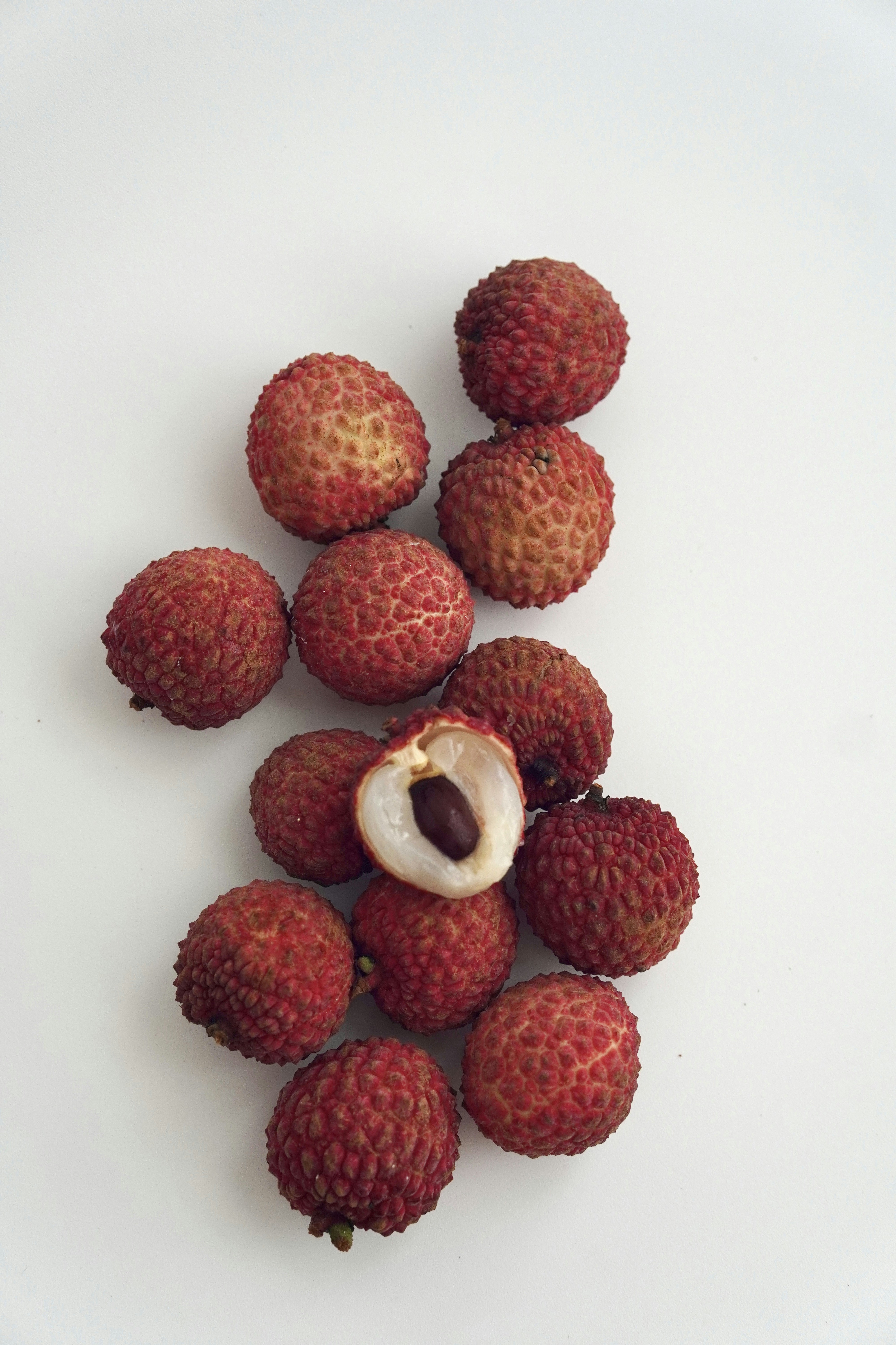 Cluster of ripe lychee-like fruits with one split open