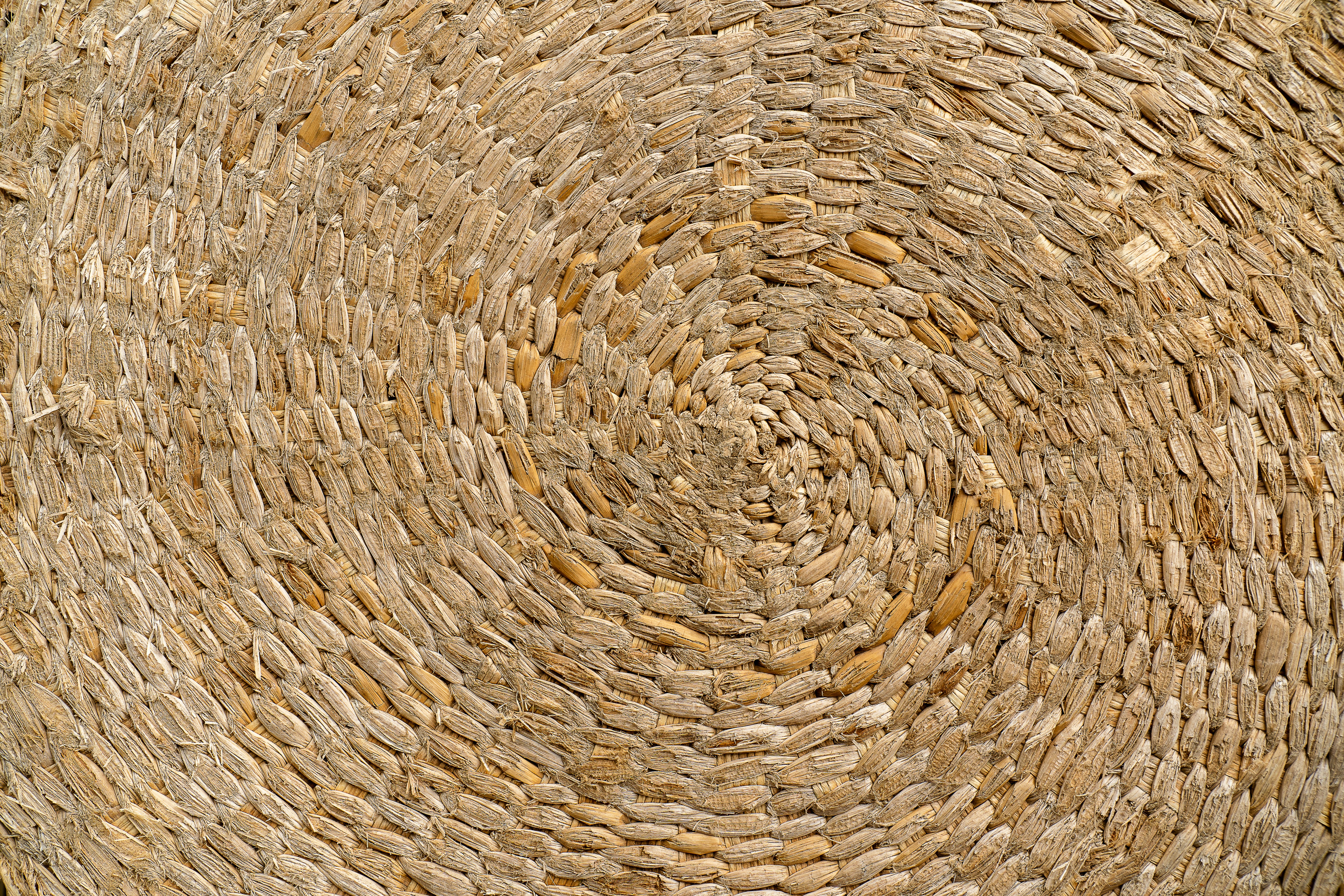 Natural circular woven straw mat texture neutral beige rustic background