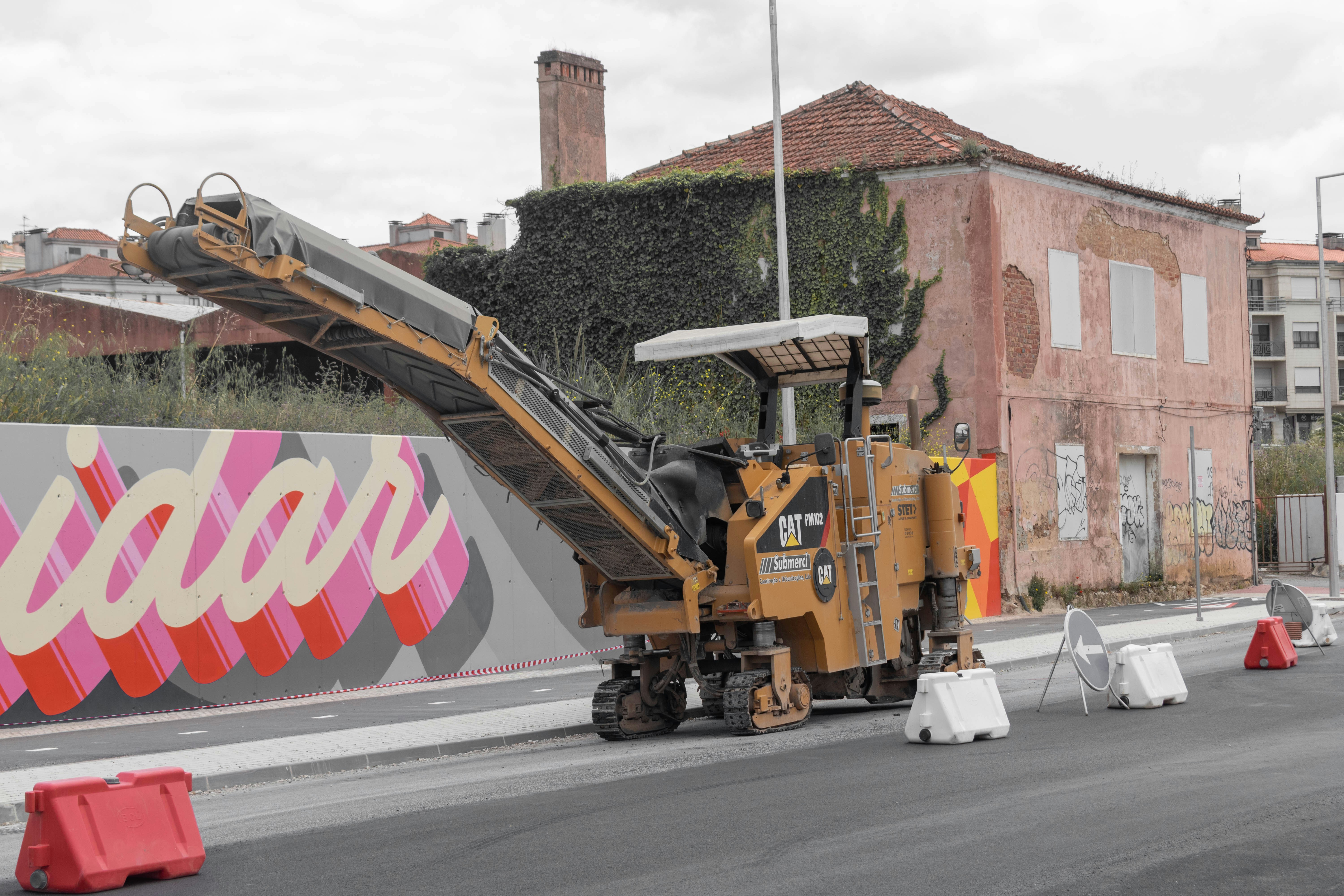 Road-Repair Machinery on City Street Amid Architectural Backdrop