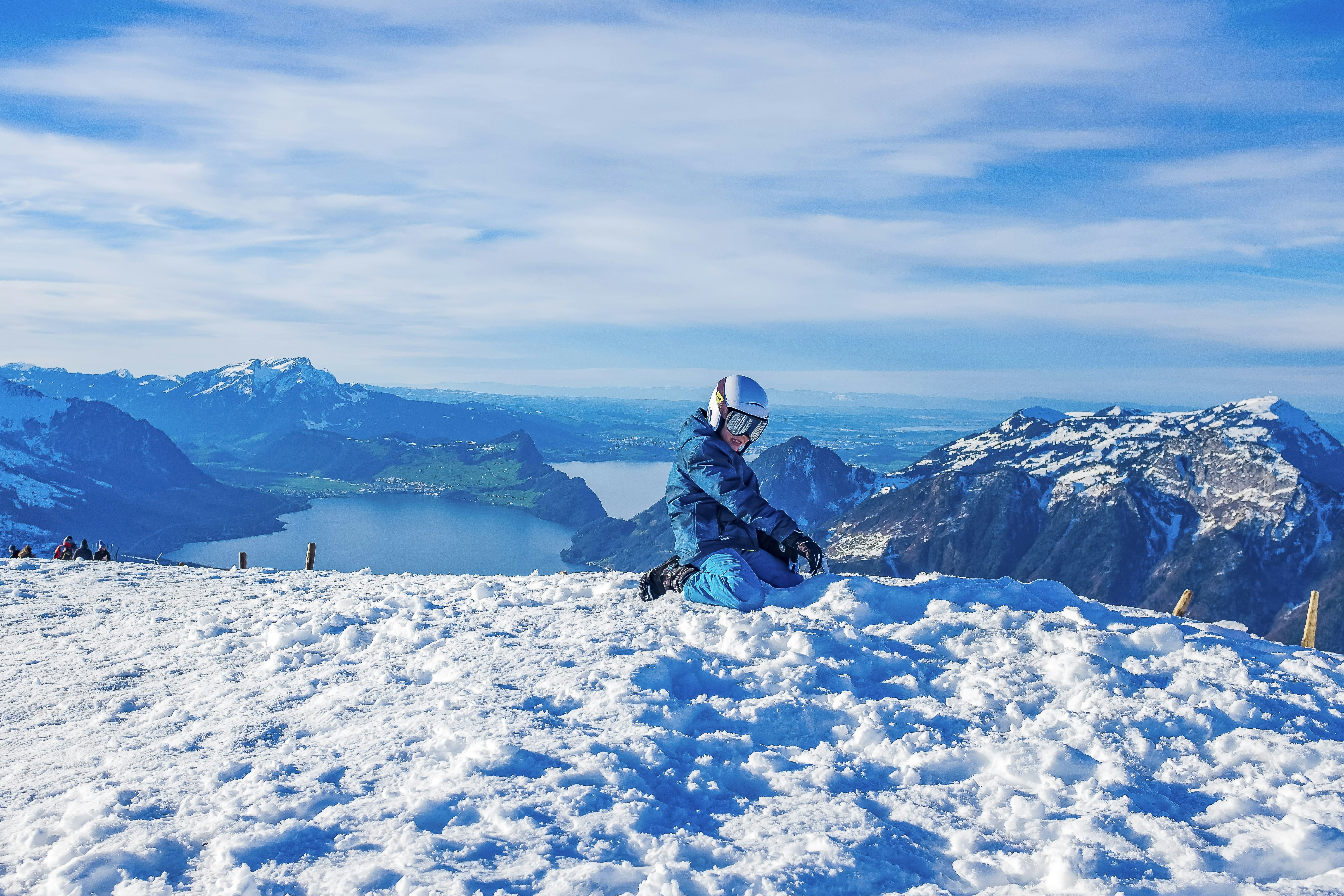 Snowbound Silhouette: A Lone Snowboarder Amid Alpine Blue