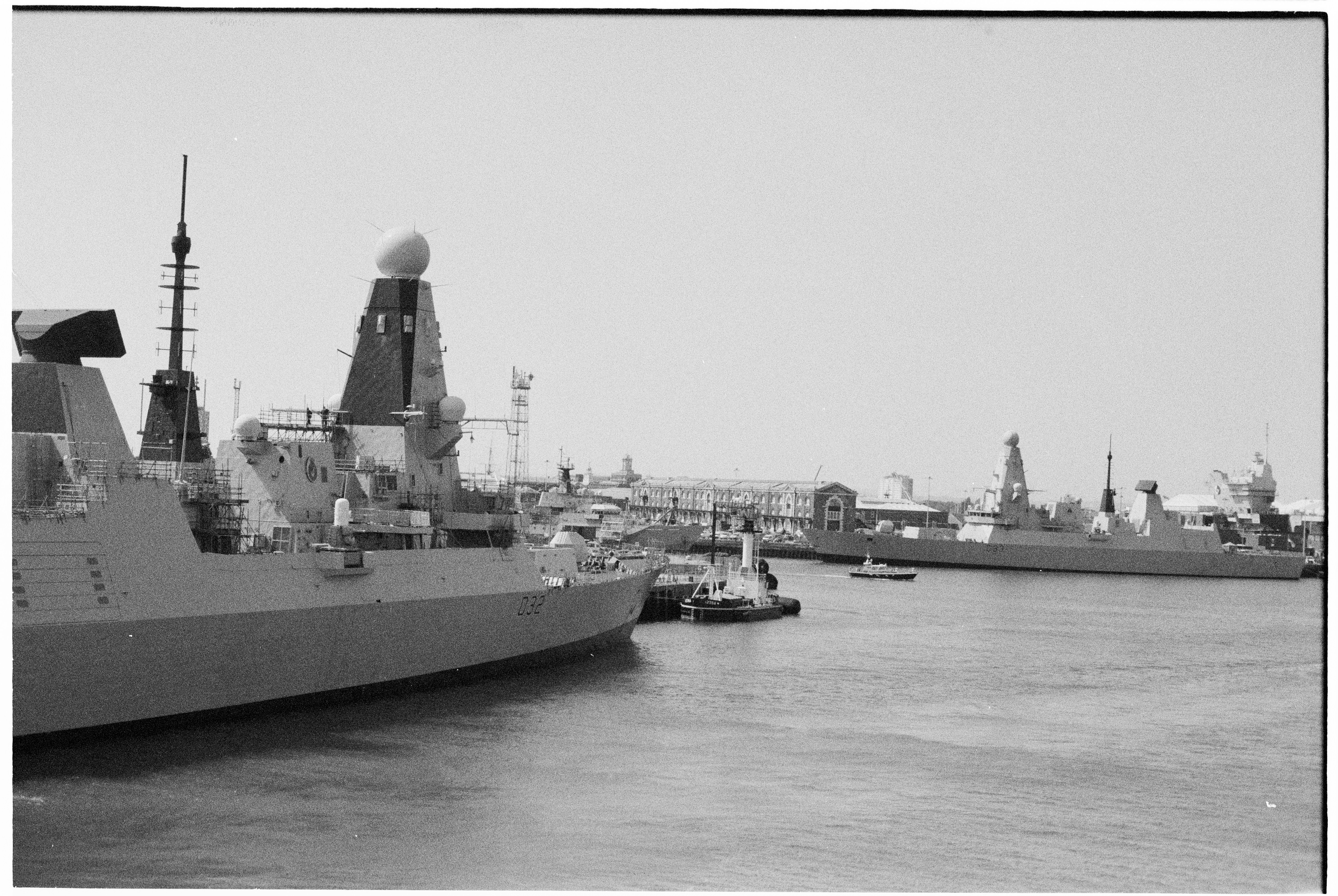 Harbor of Steel: Tugs and Battleships at Rest