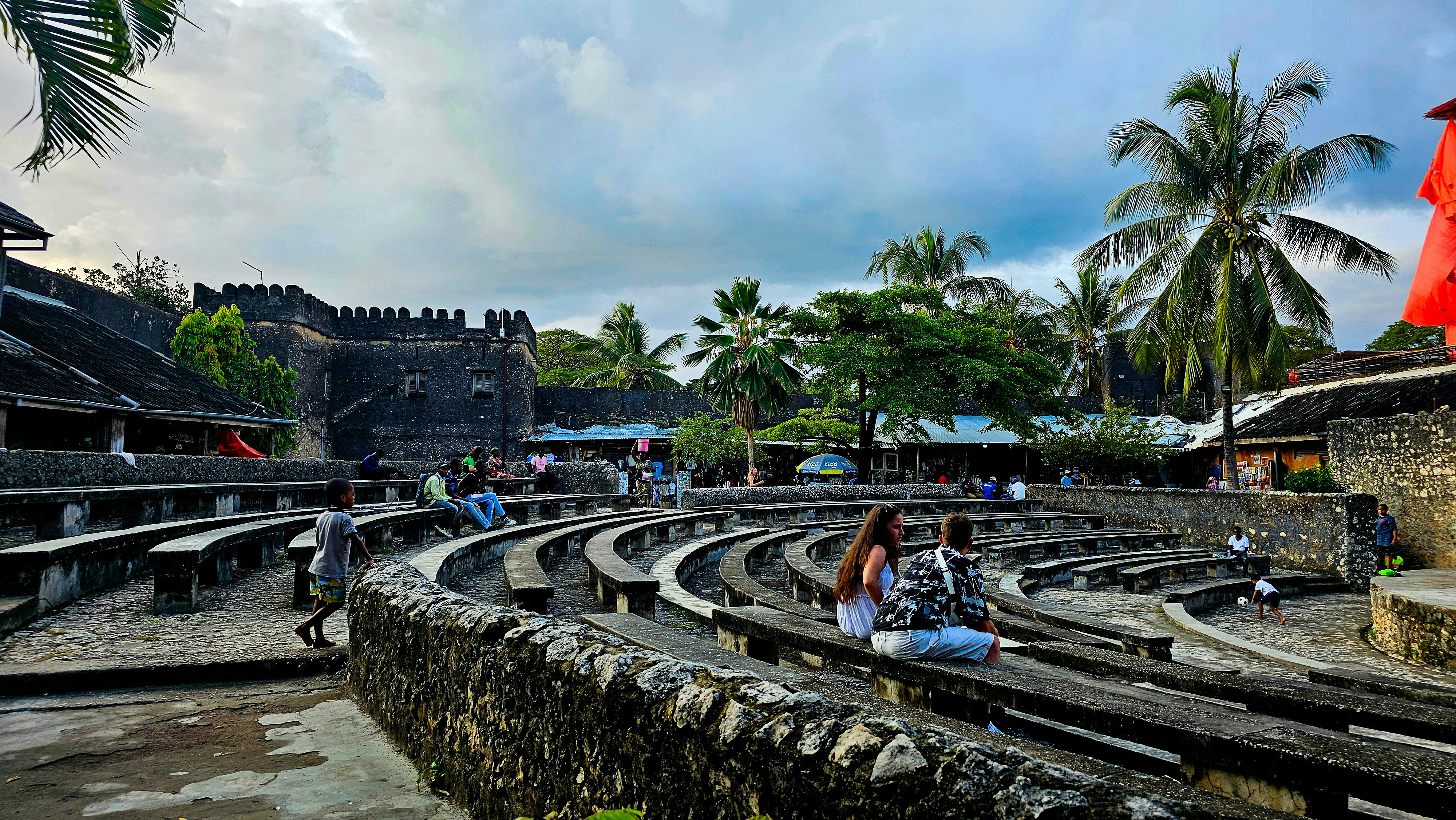 Circular Terrace at Fort Cochin: Stone Seats, Palm Shadows, and Sunset Sky