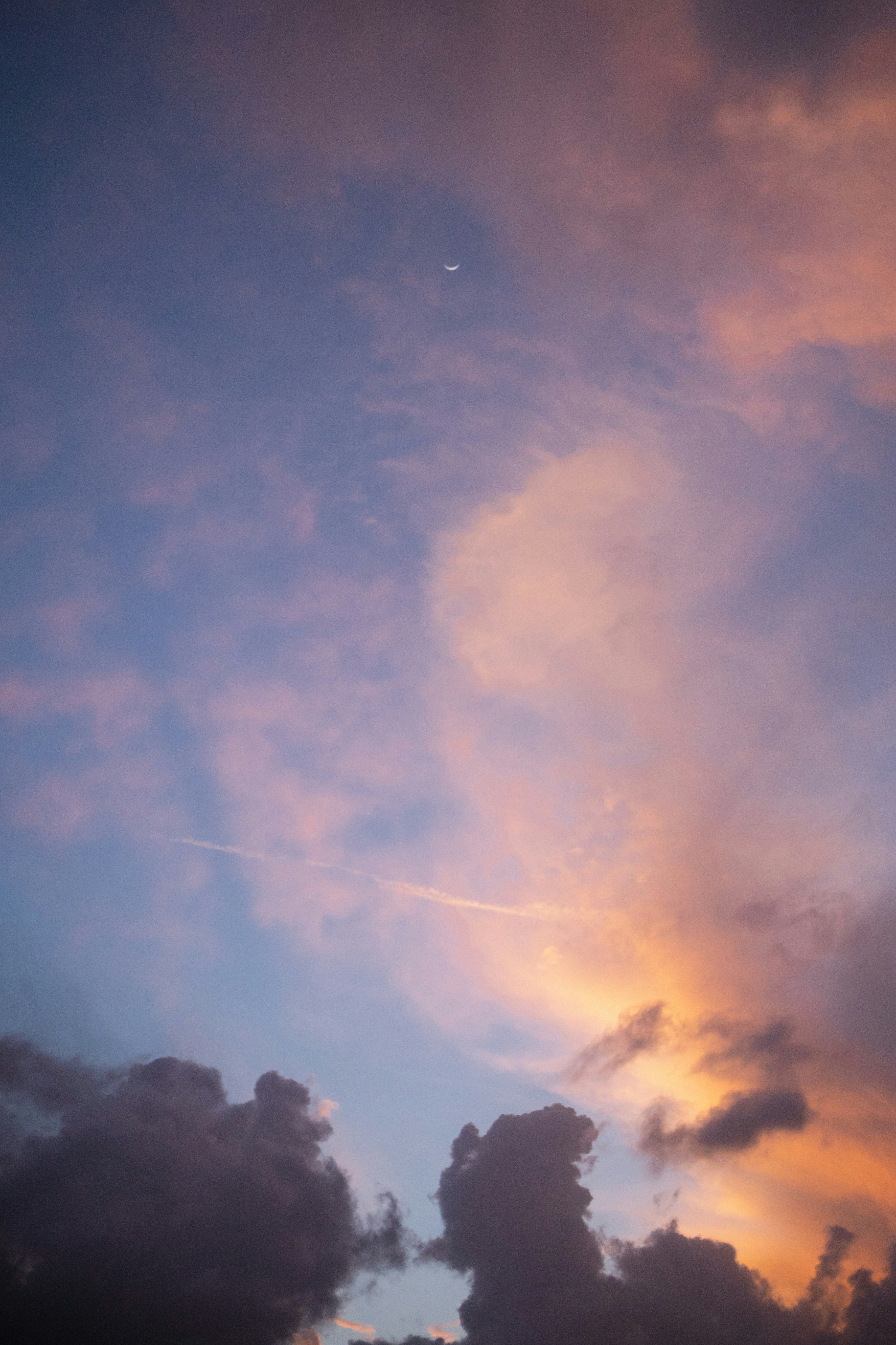 Skyfire in Twilight: Crescent Moon Above Turbulent Clouds