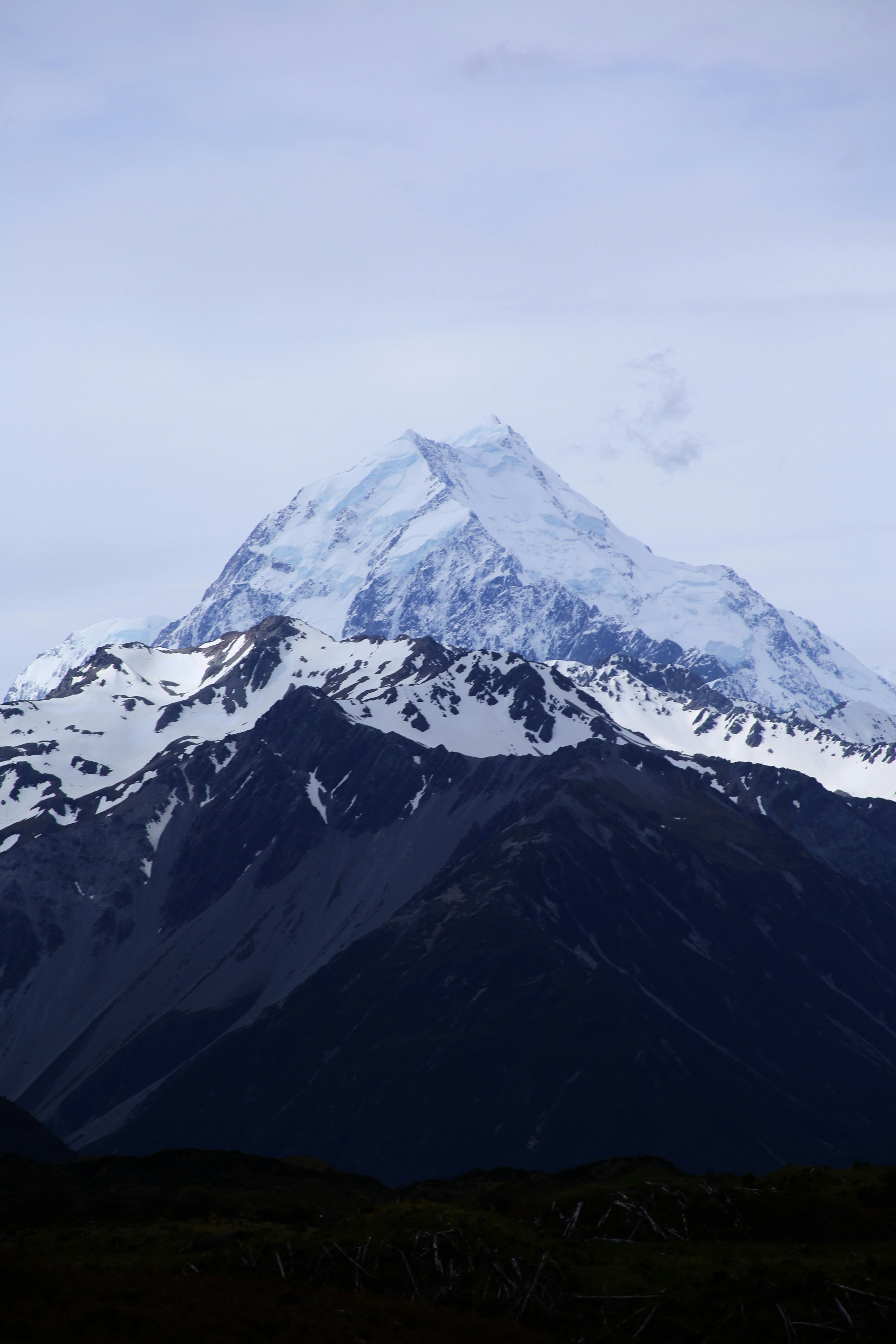 A Silent Peak: Snow Crowned Summit Rising Over Dark Fjords
