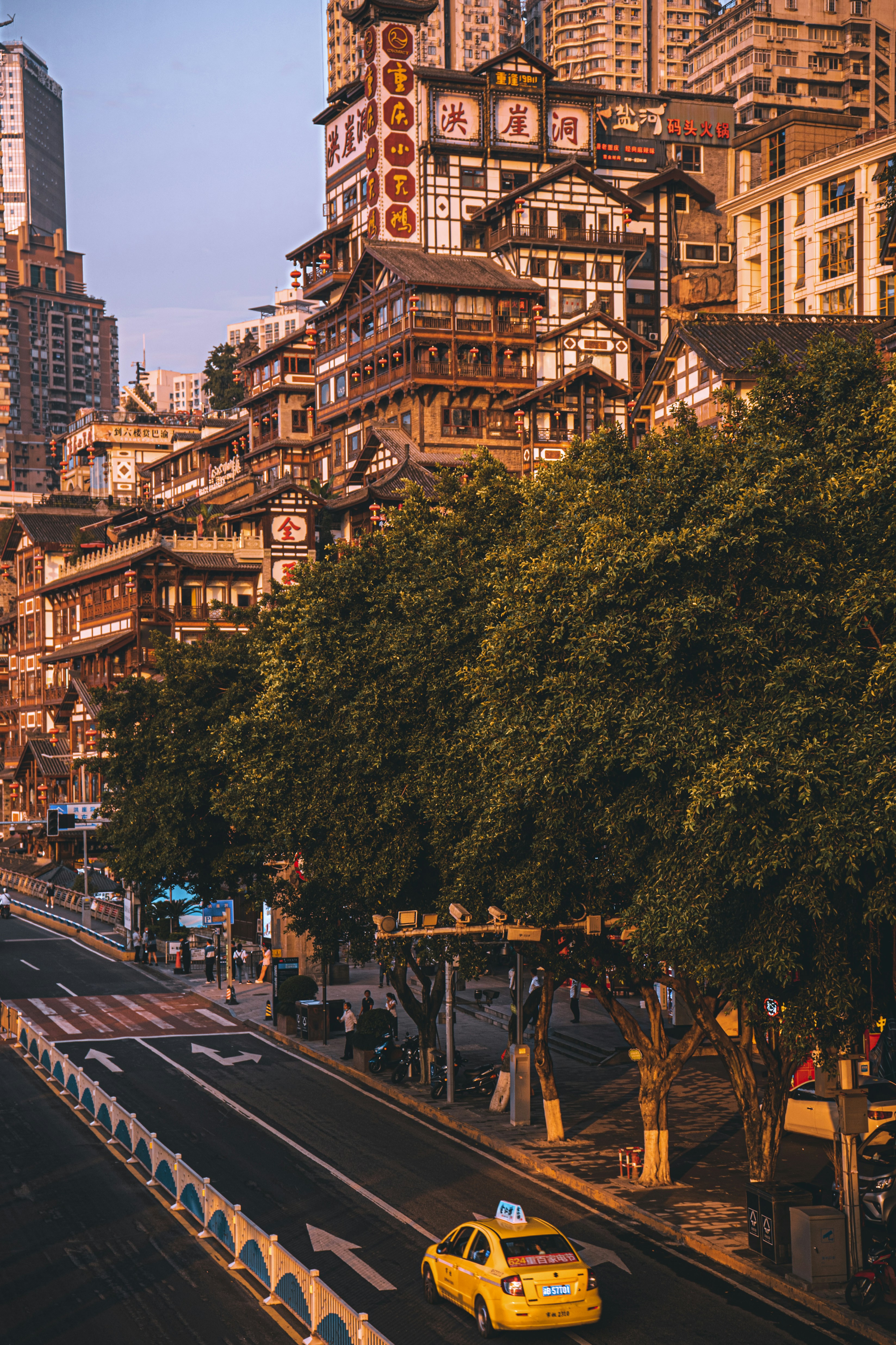 City of Lanterns and Lanes: A Busy Riverside Road Under Traditional Rooftops