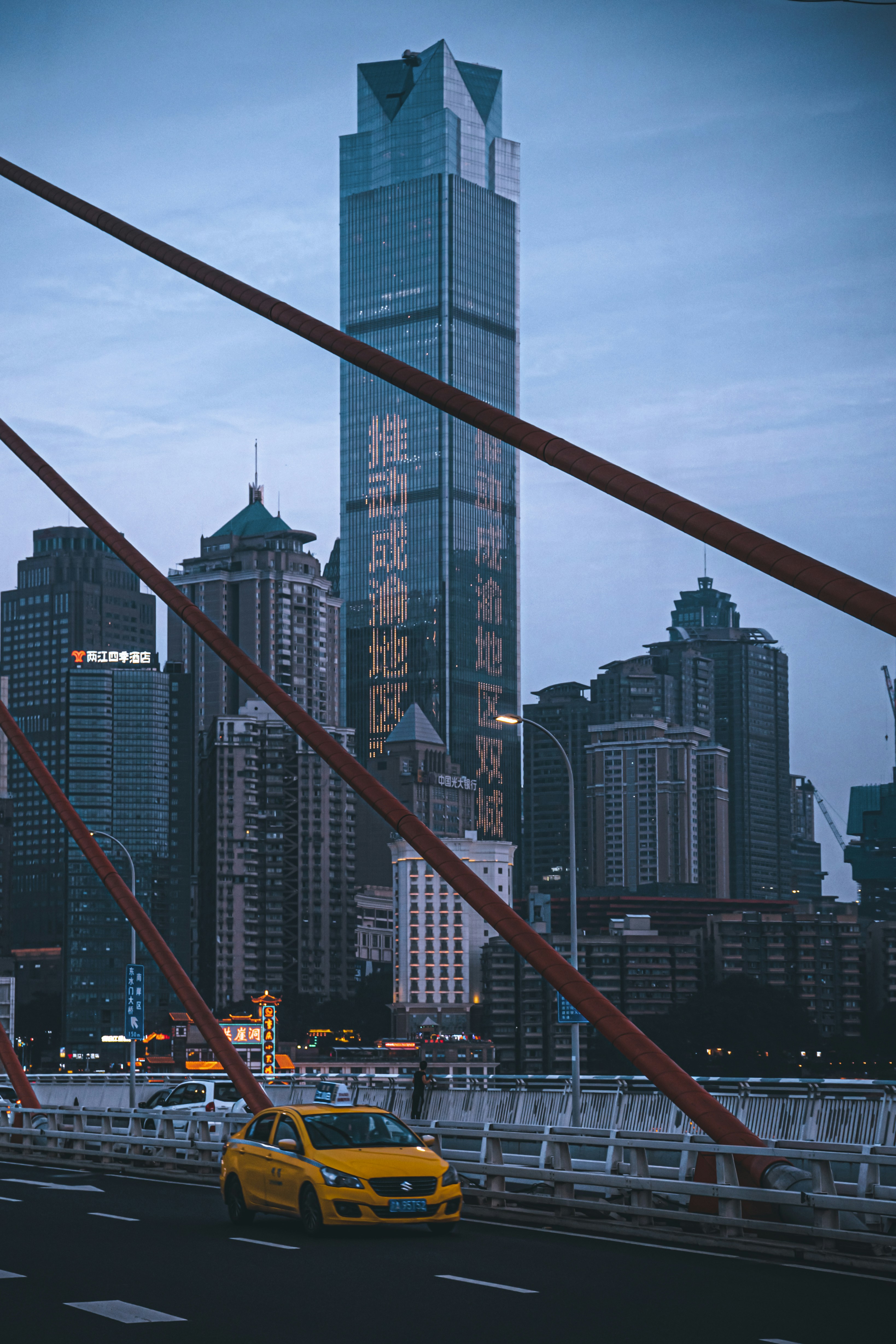 Yellow Taxi Crossing the Urban Sea of Towers